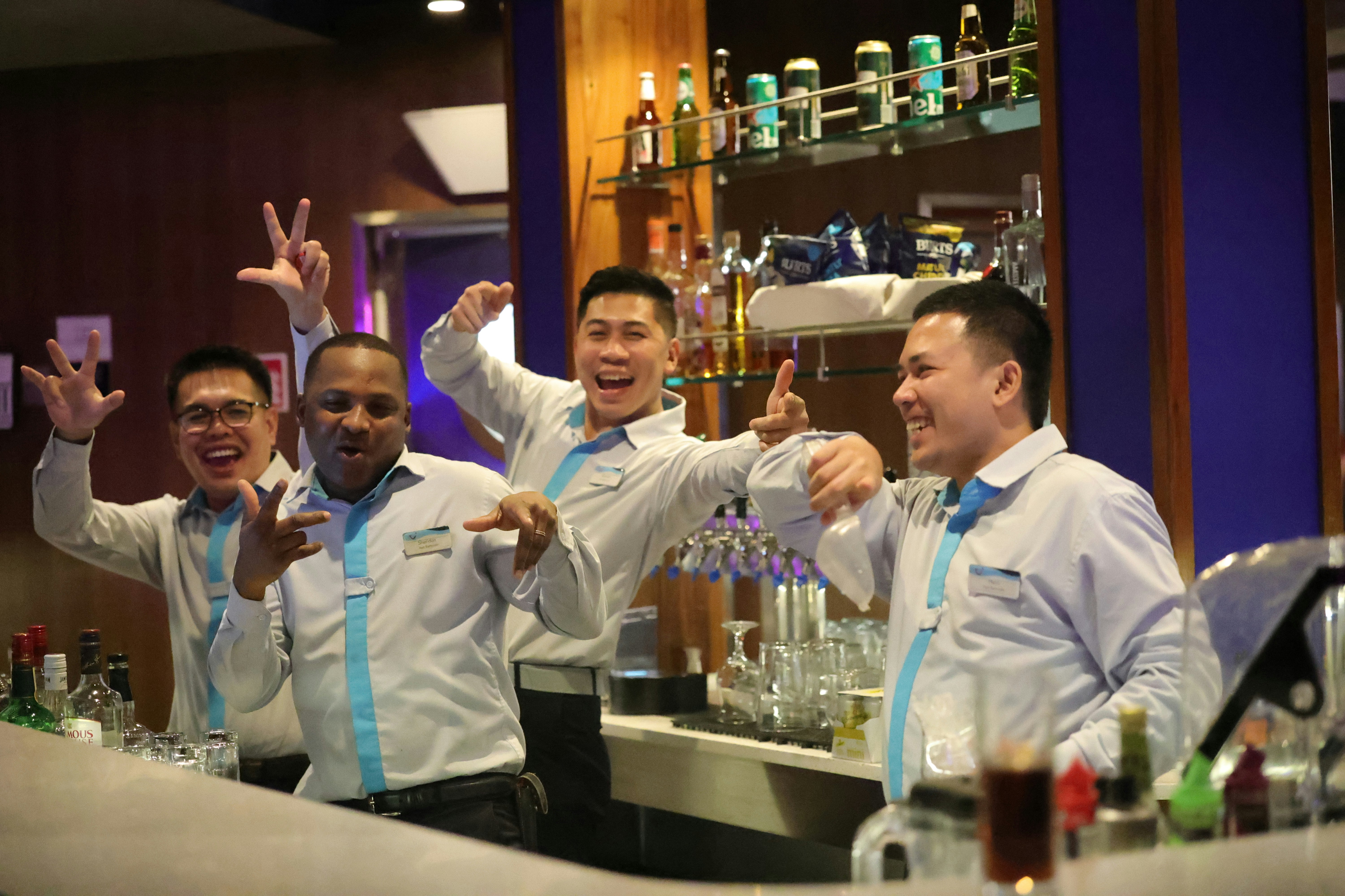Bar crew capture: jubilant cheers behind the bar
