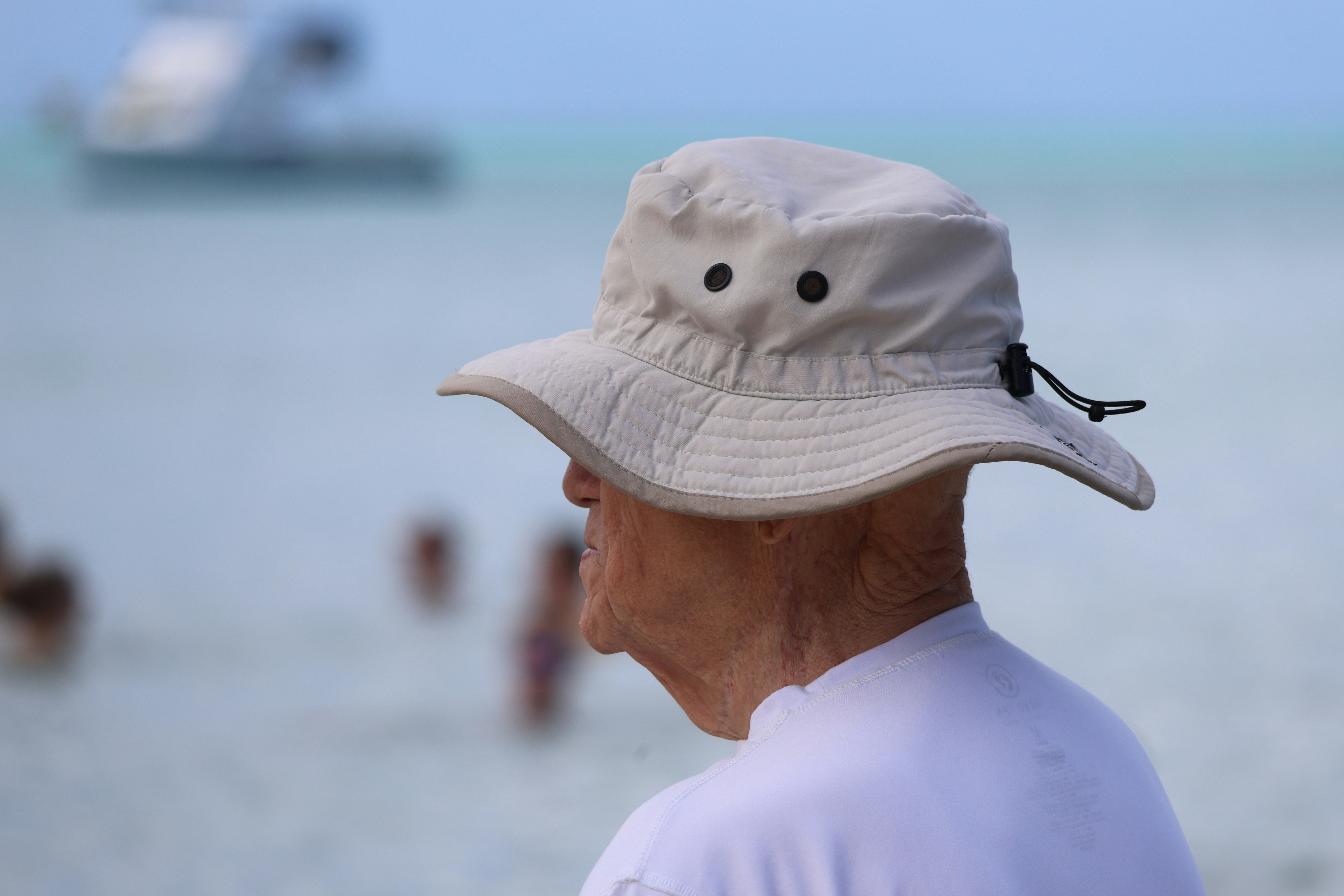 Hat and Sea: The Silent Portrait of a Beach Elder