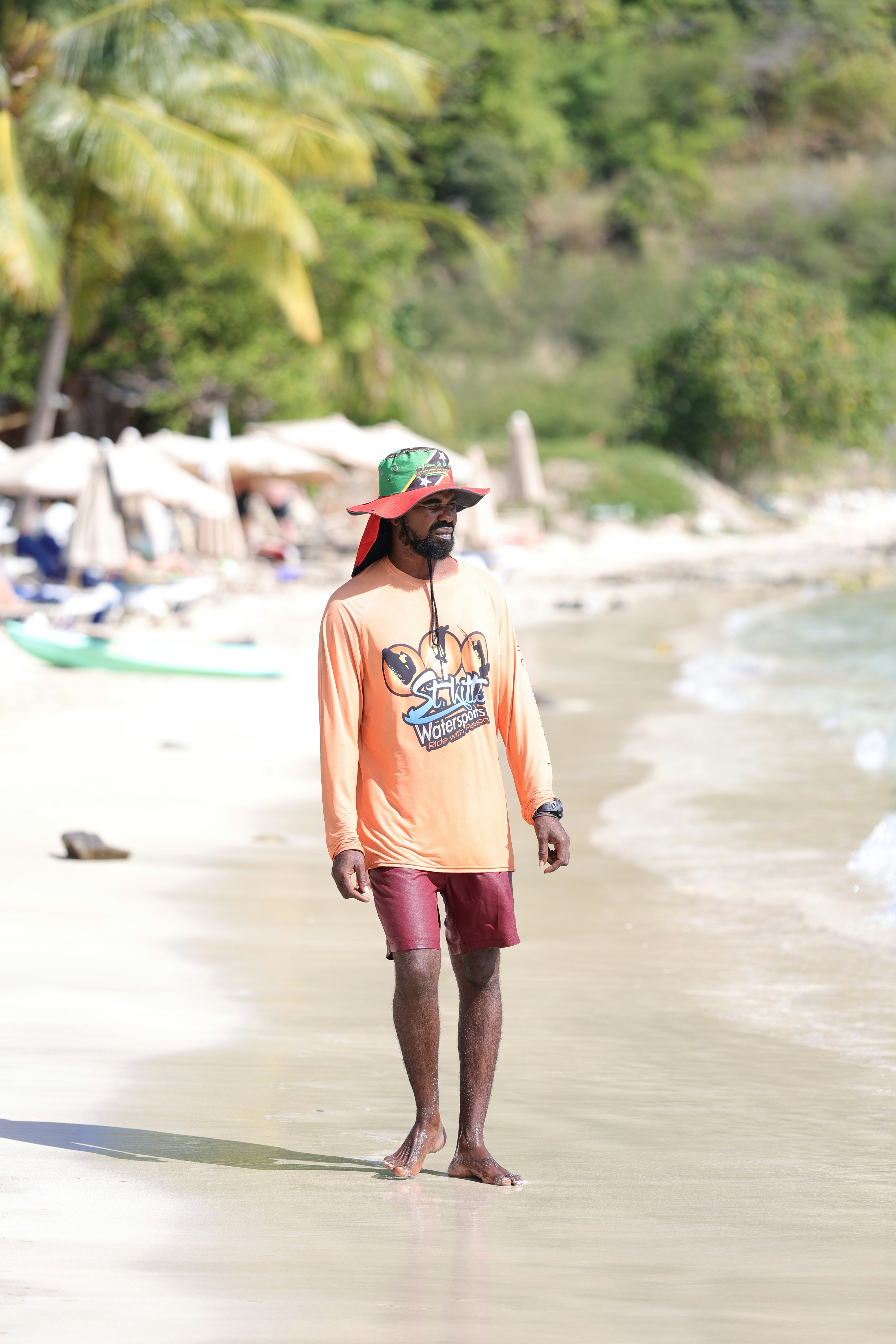 Sunlit Beach Surfer in Orange Sweatshirt and Wide-Brim Hat