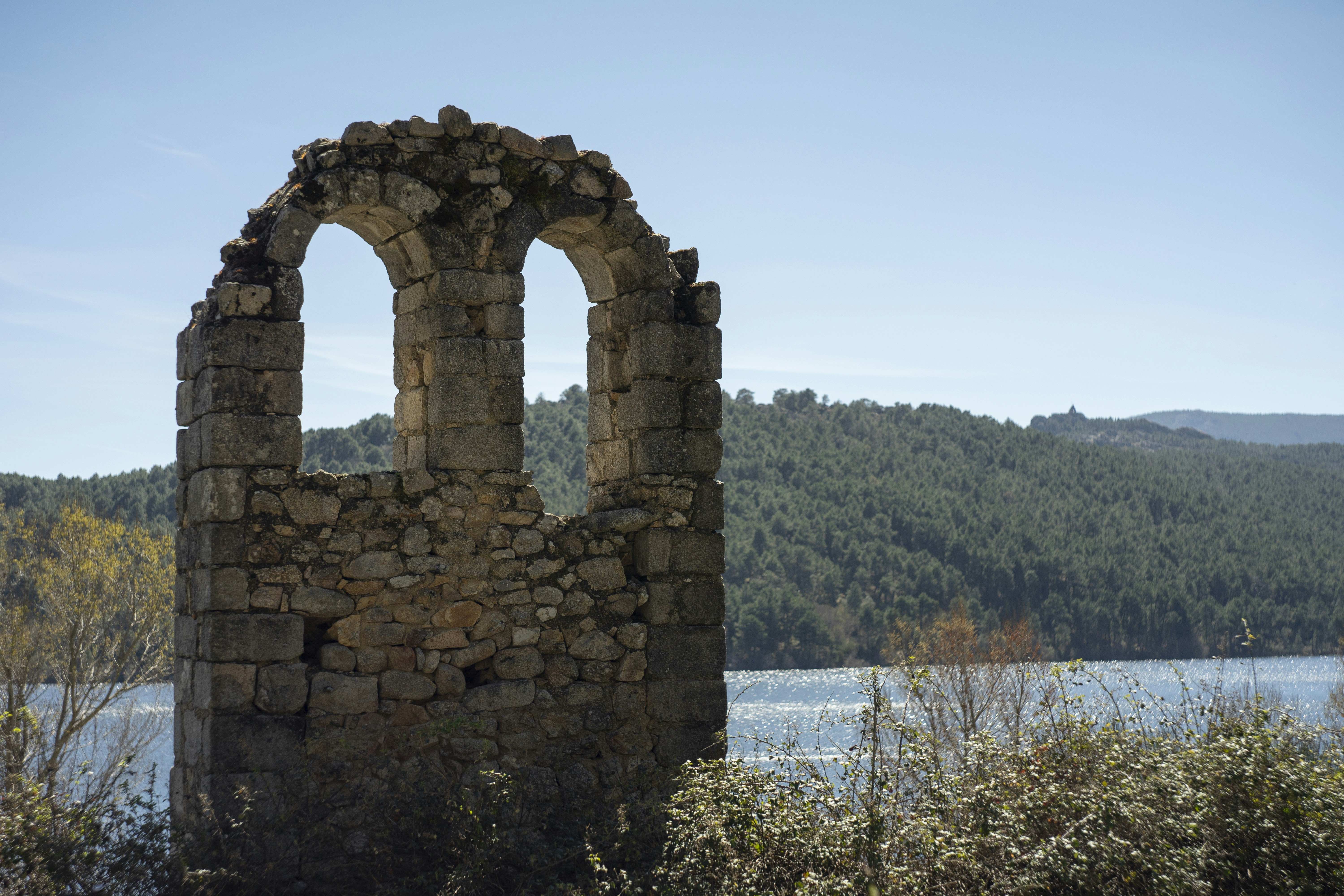 Stone Arch Remnant by a Quiet Lake