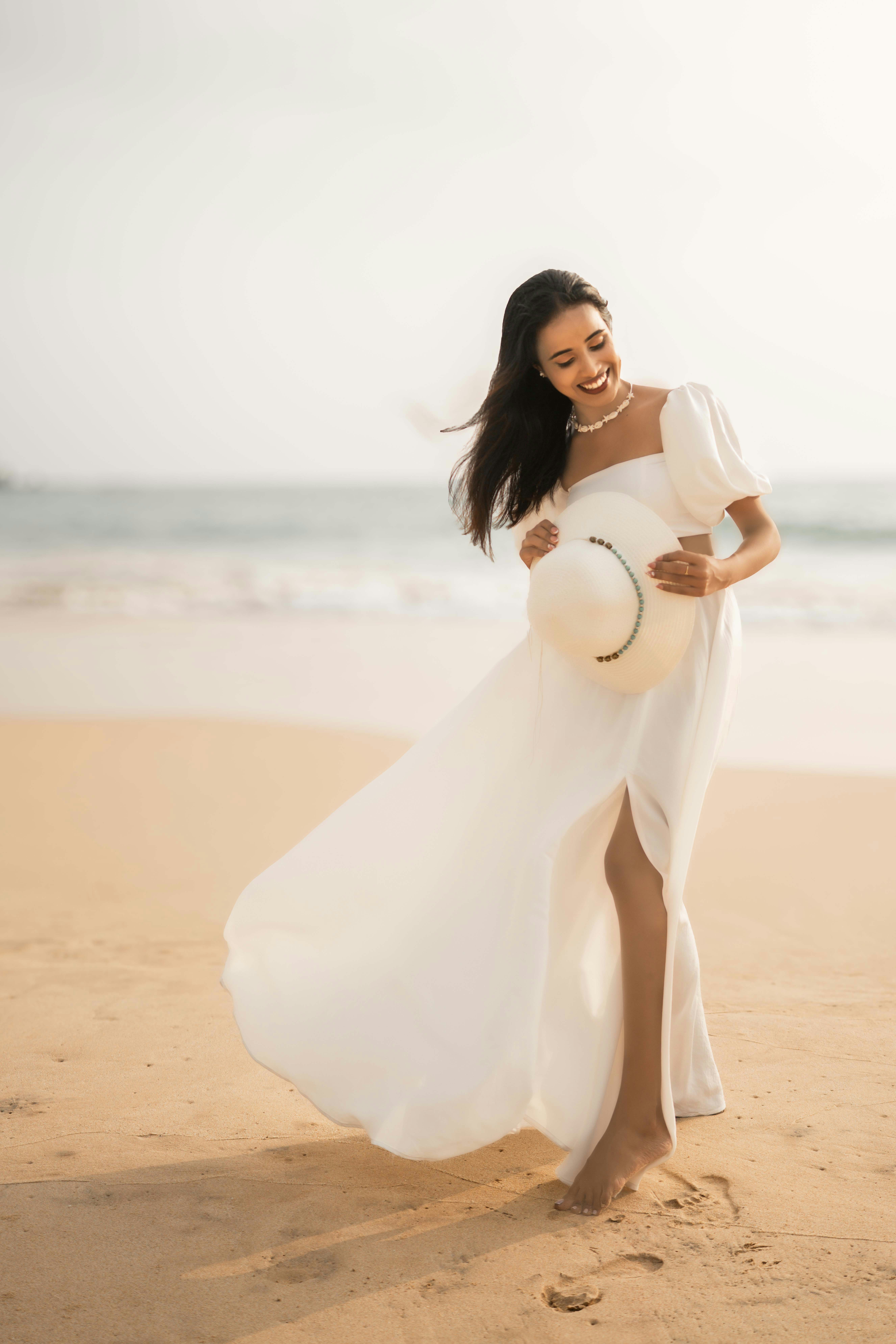 White dress on the breeze: a seaside dance on sunlit sand
