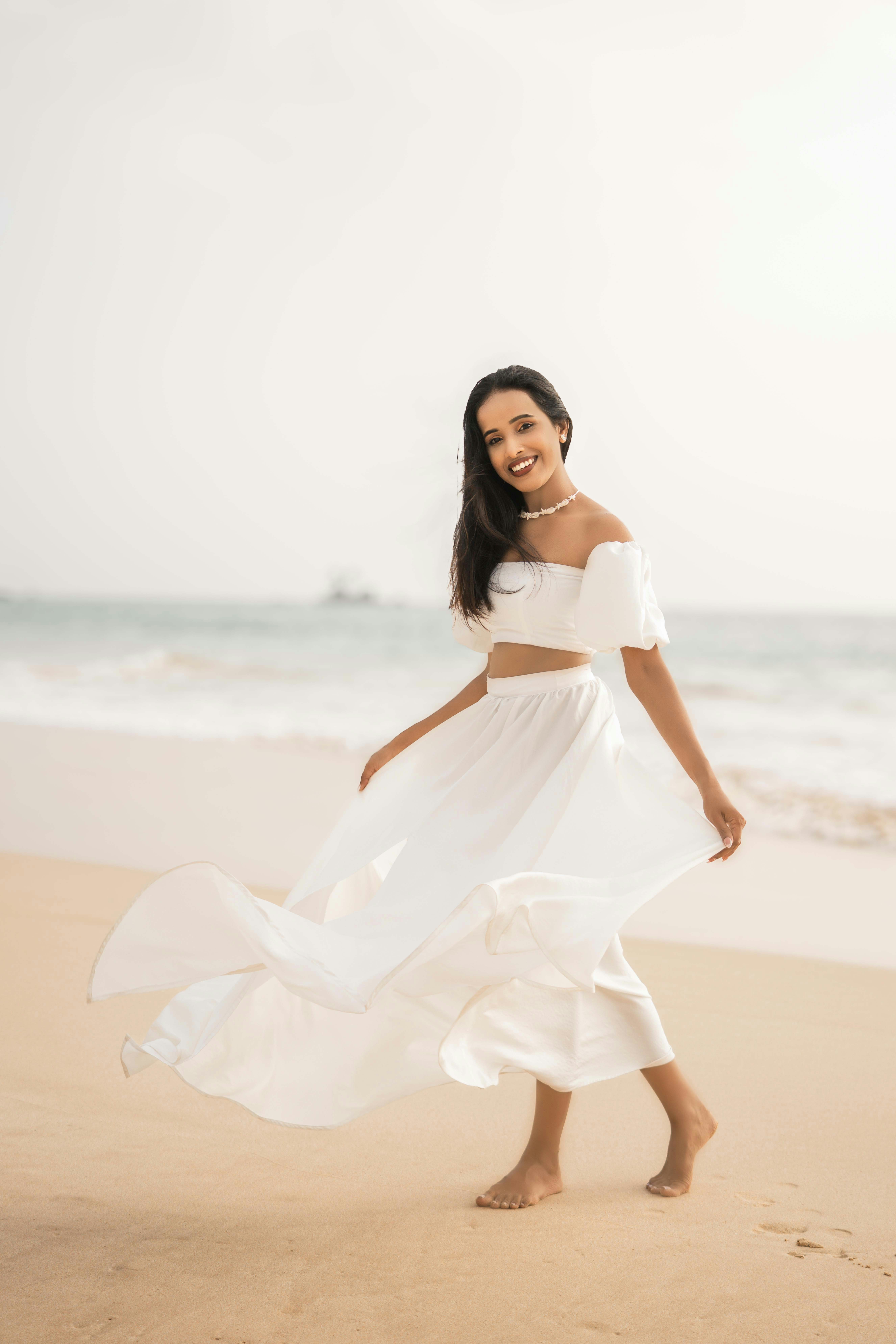 Sunlit White dress on the Shoreline: a dancer at sea-breeze moment