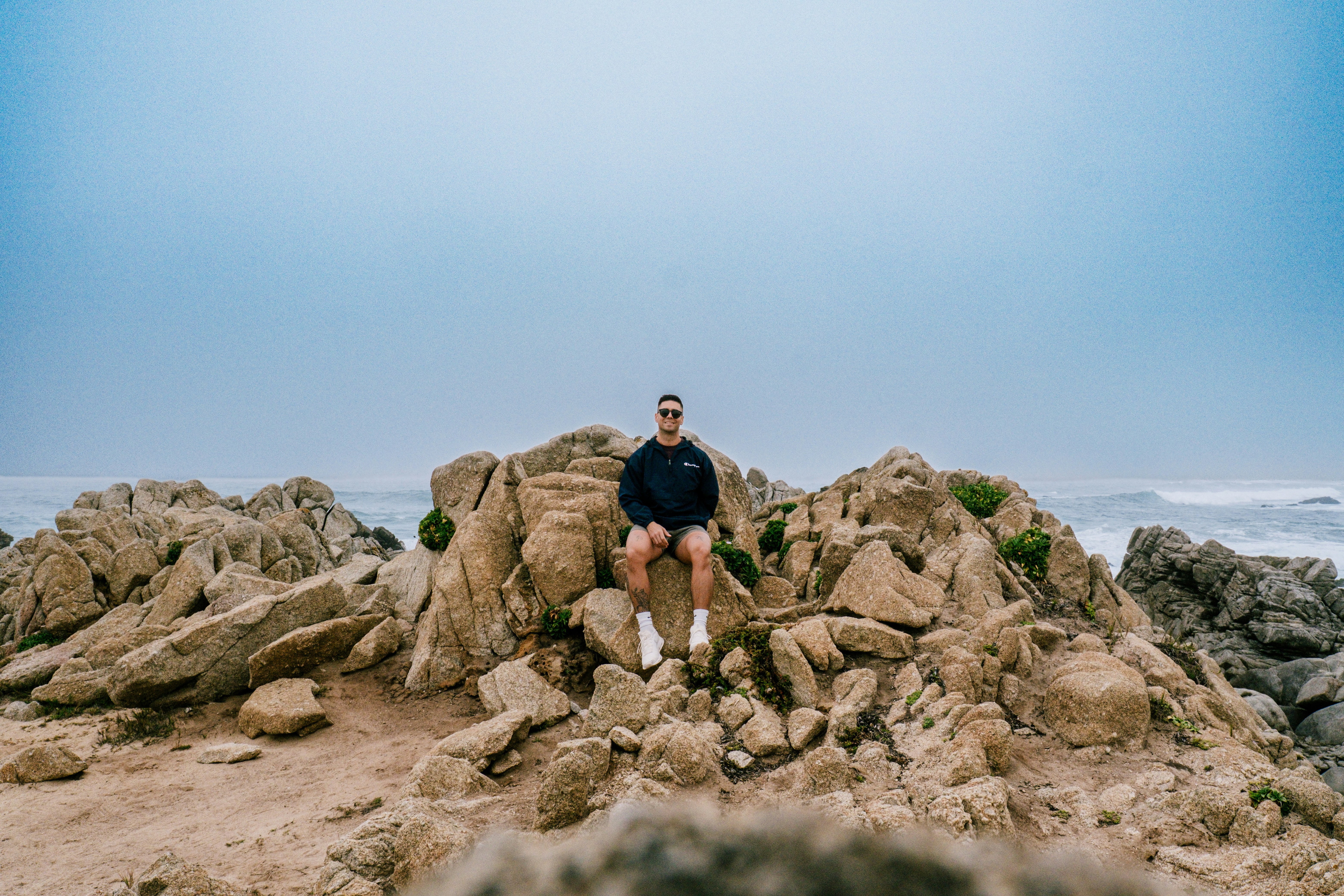 Solitary Figure Reigning Over Sea-Sculpted Rocks