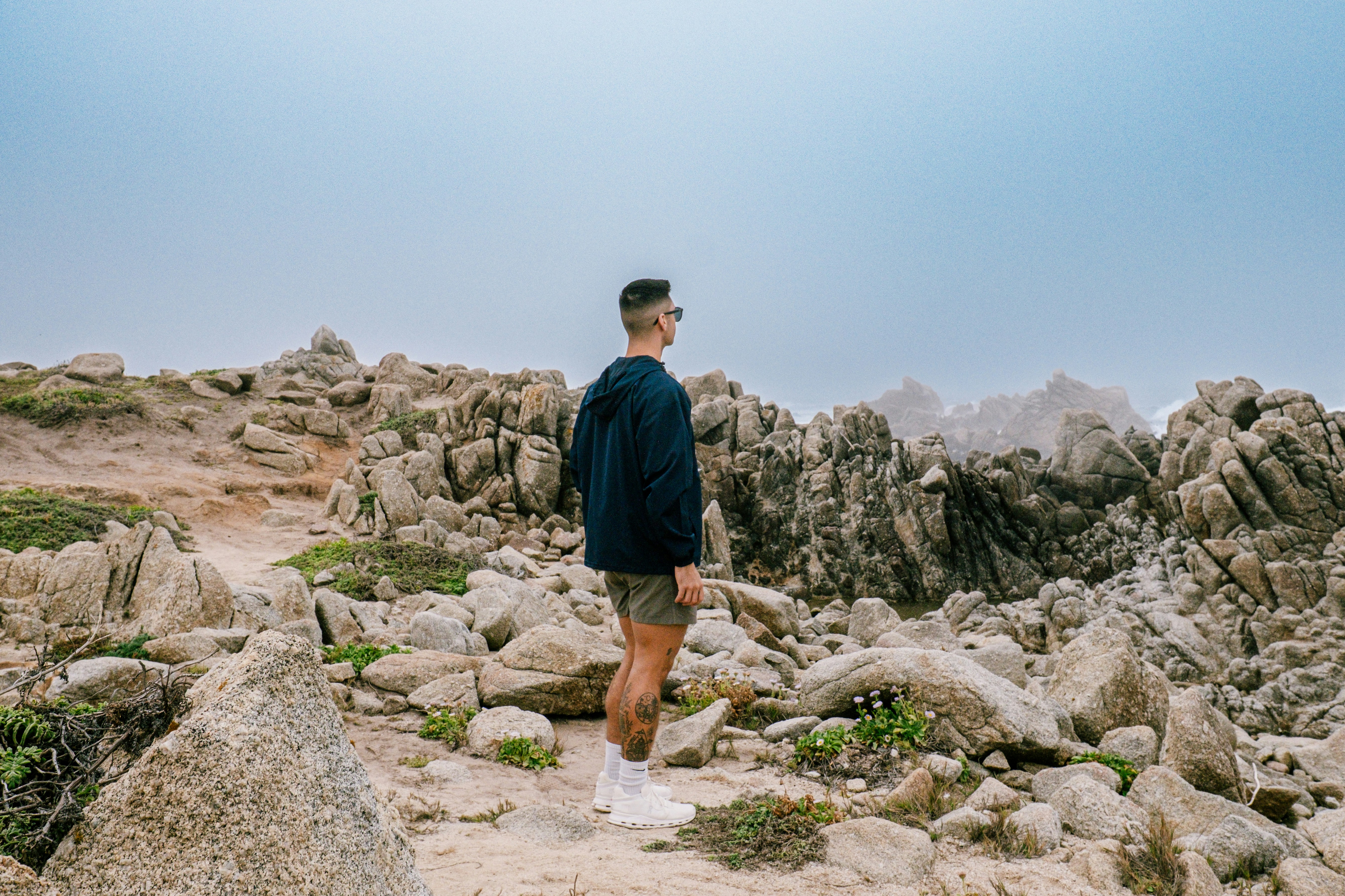 Man in a Sandstone Coastline: Exploring the rugged shore
