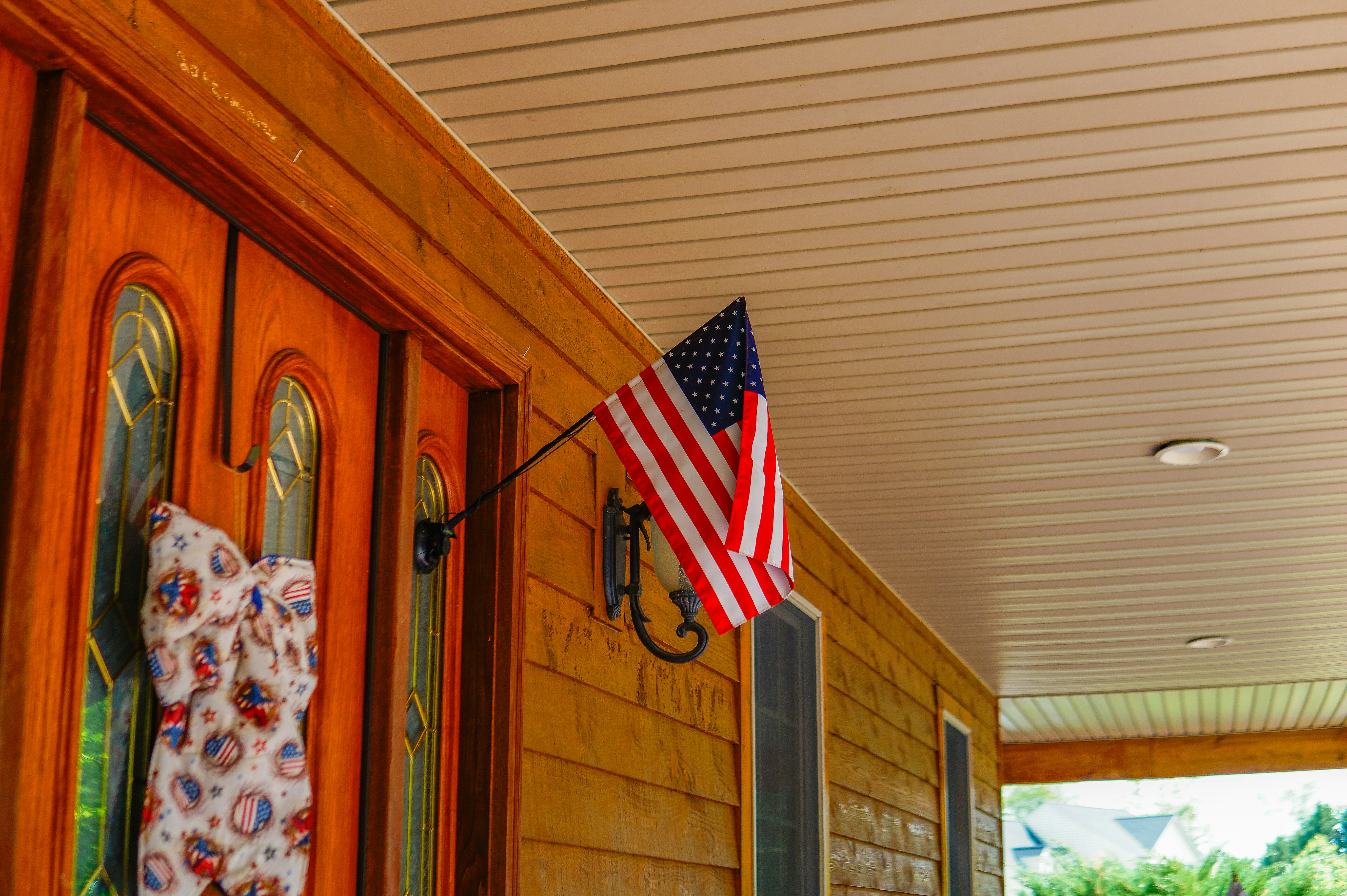 Patriotic Flag by the Wooden Porch