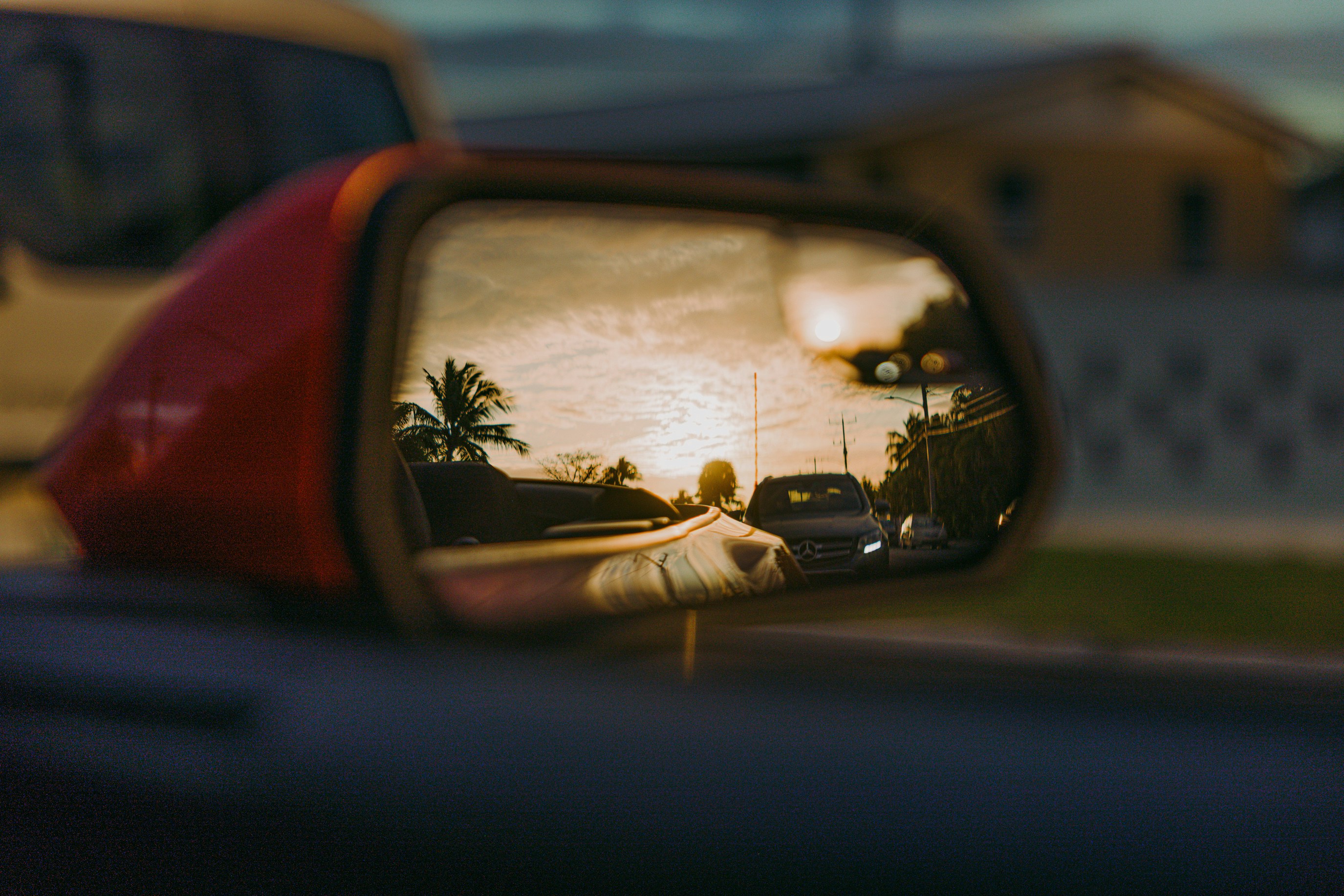 Sunset Drive: Reflections in a Car Mirror