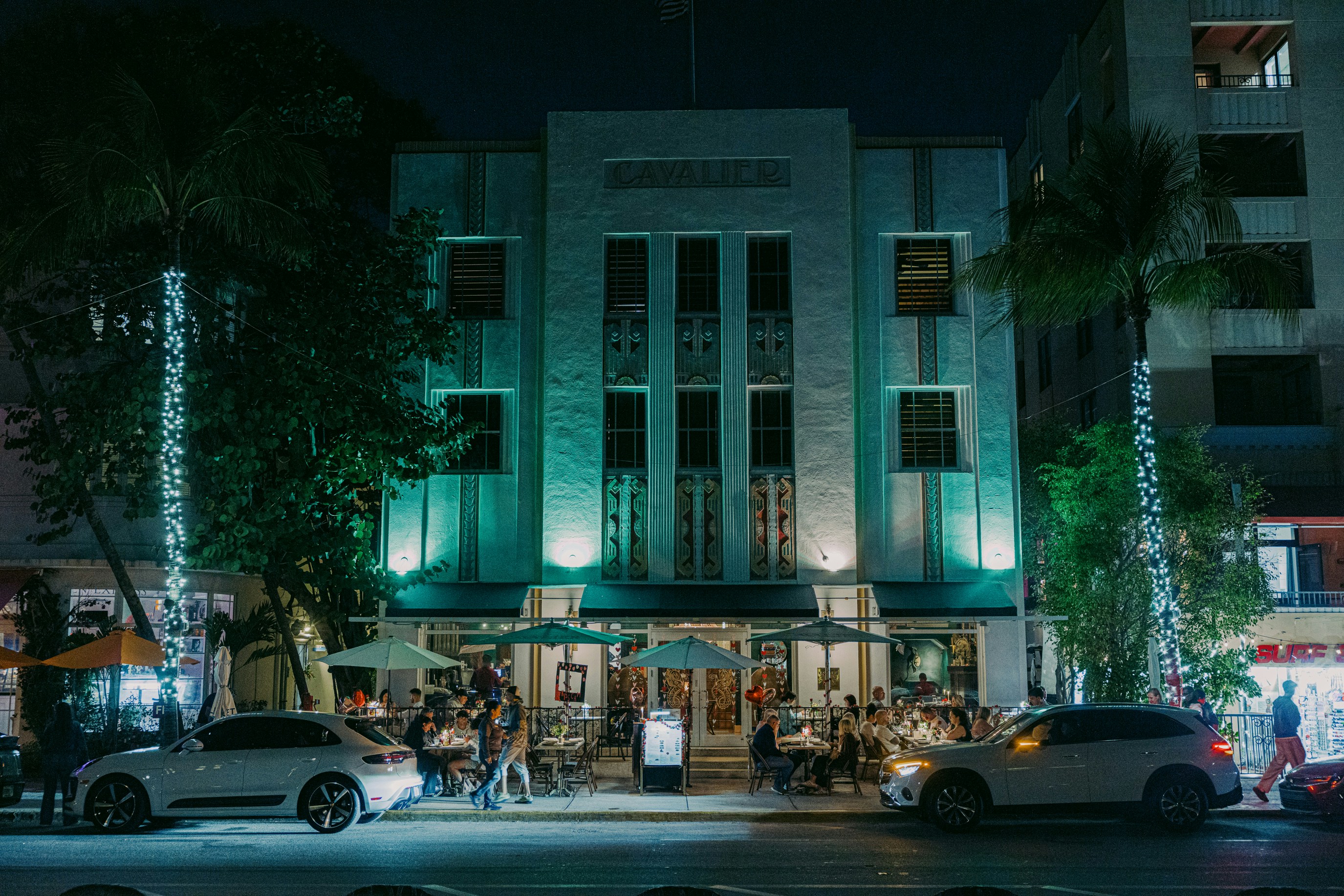 Neon Facade Nightflight: Café Terrace in Blue-Green Glow