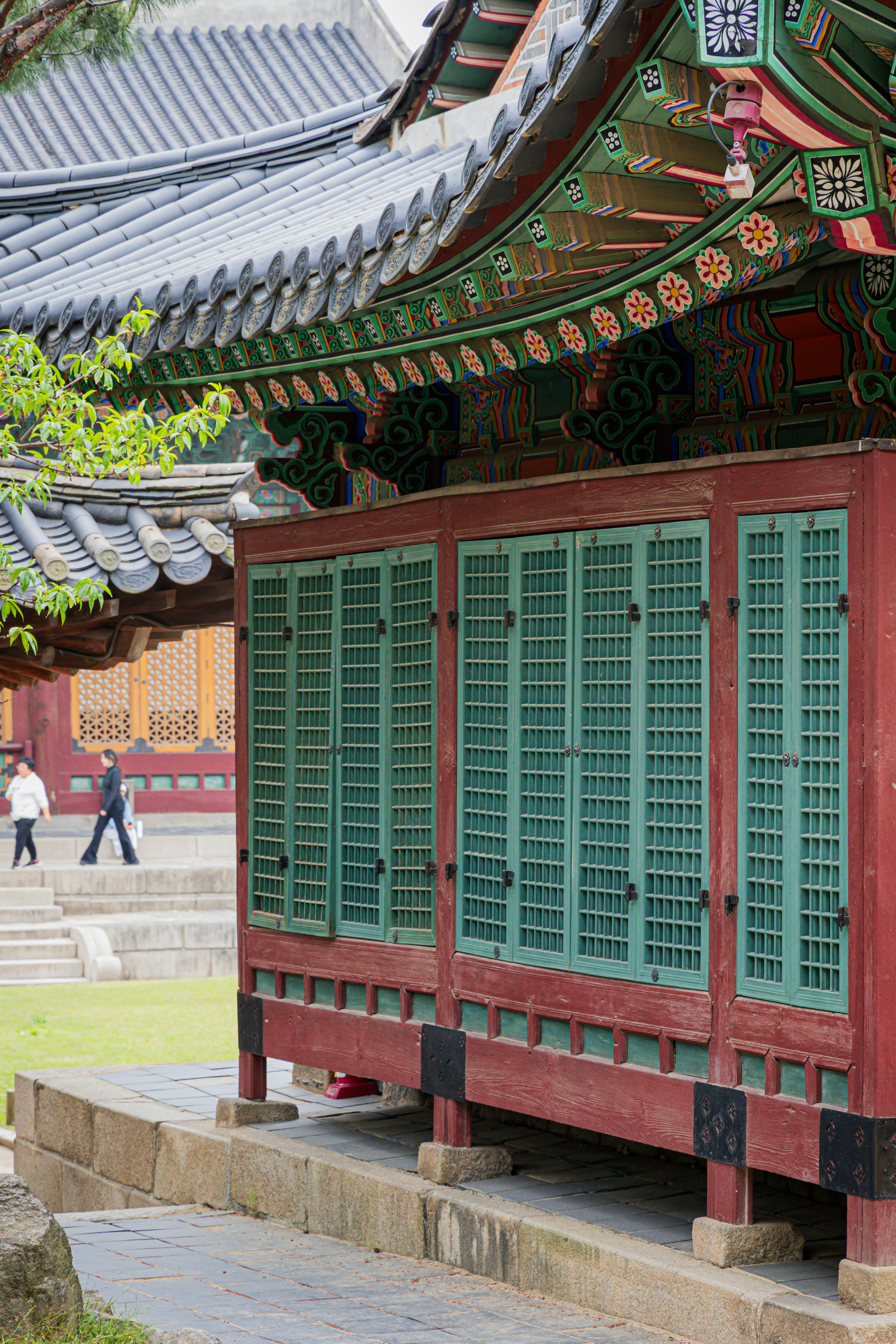 Colorful eaves and teal lattice of a traditional Korean building