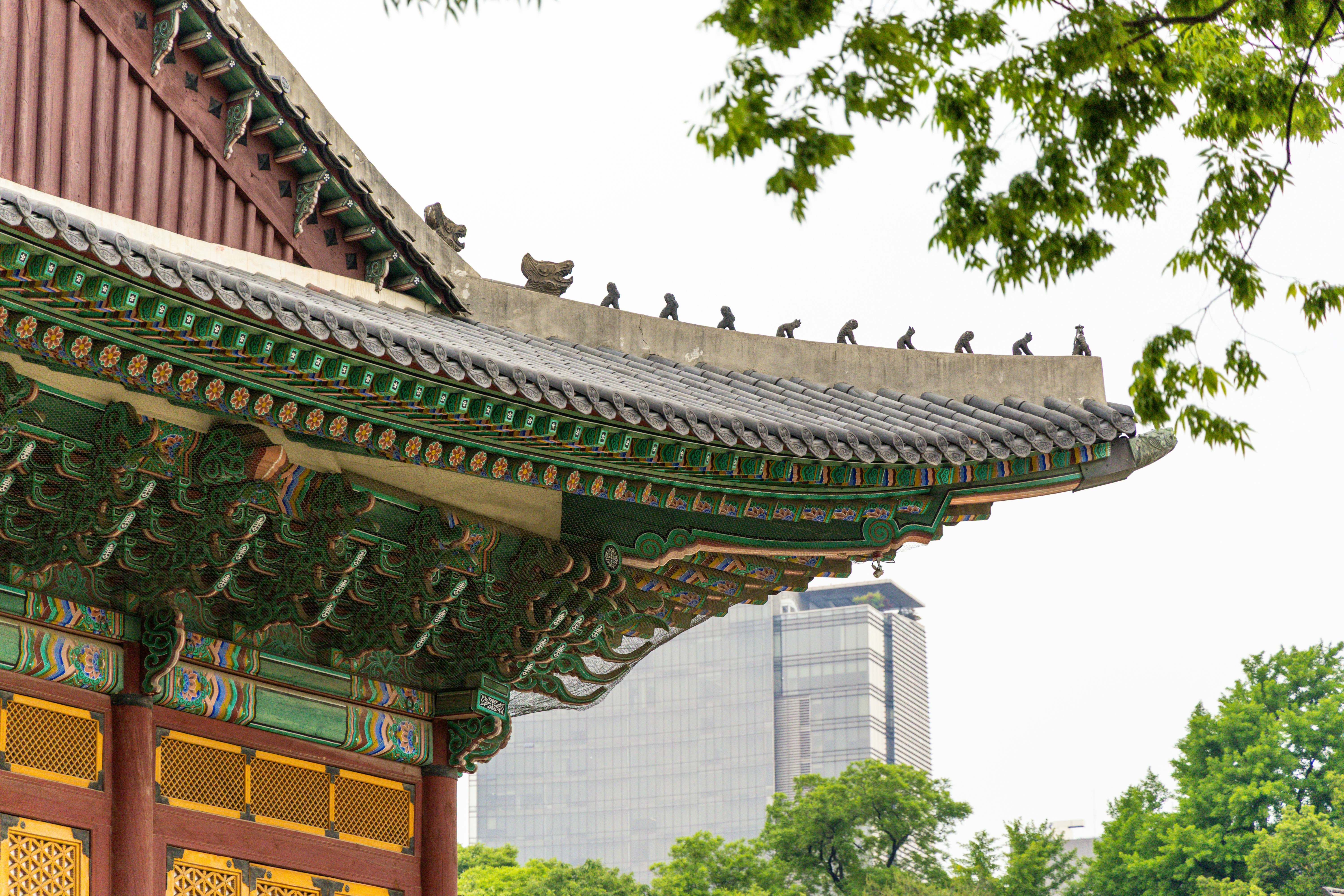 Ornate eaves and distant skyline: a traditional temple meets modern towers