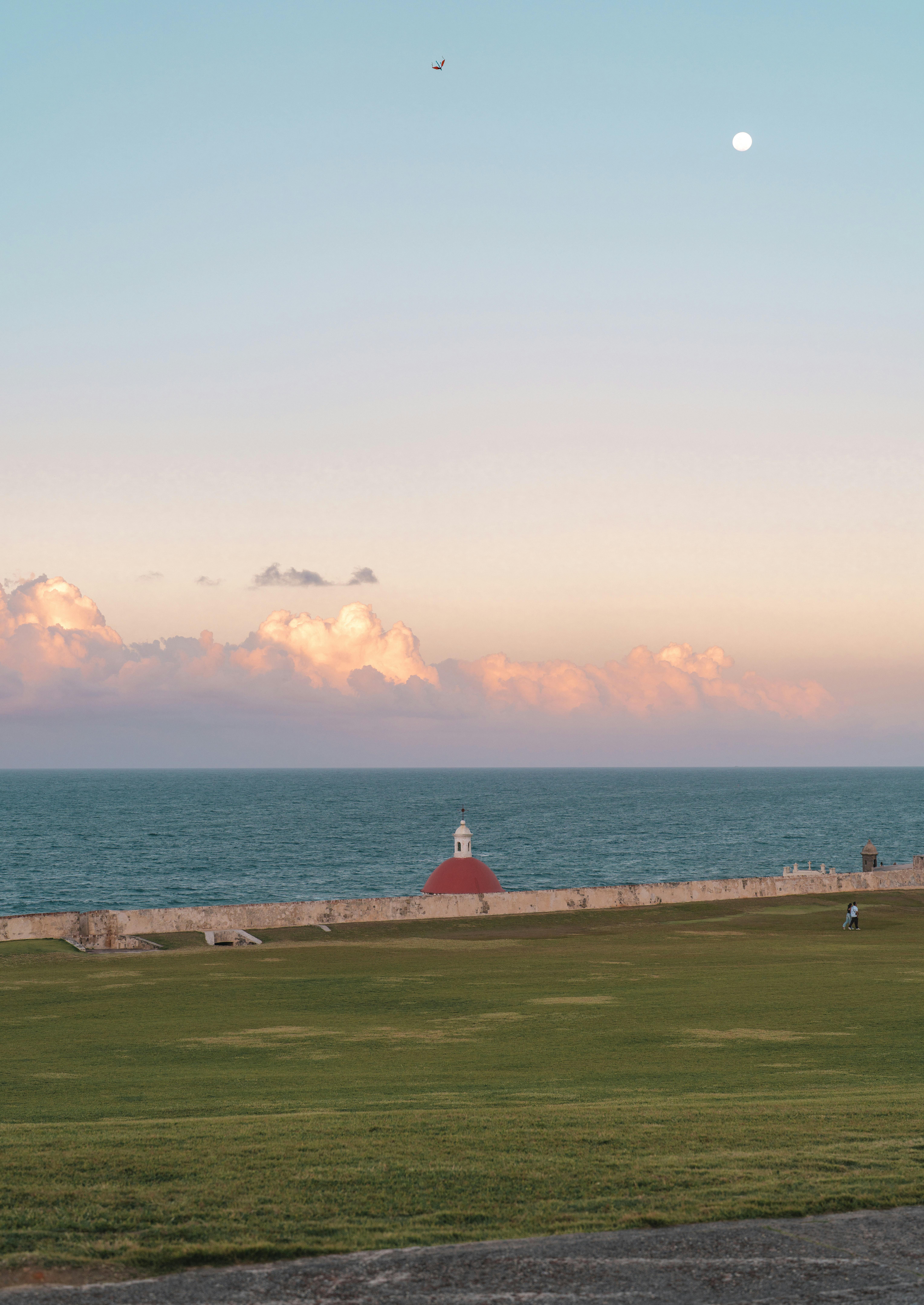 Pastel Coastline: Lighthouse, Sea, and Sky at Dusk
