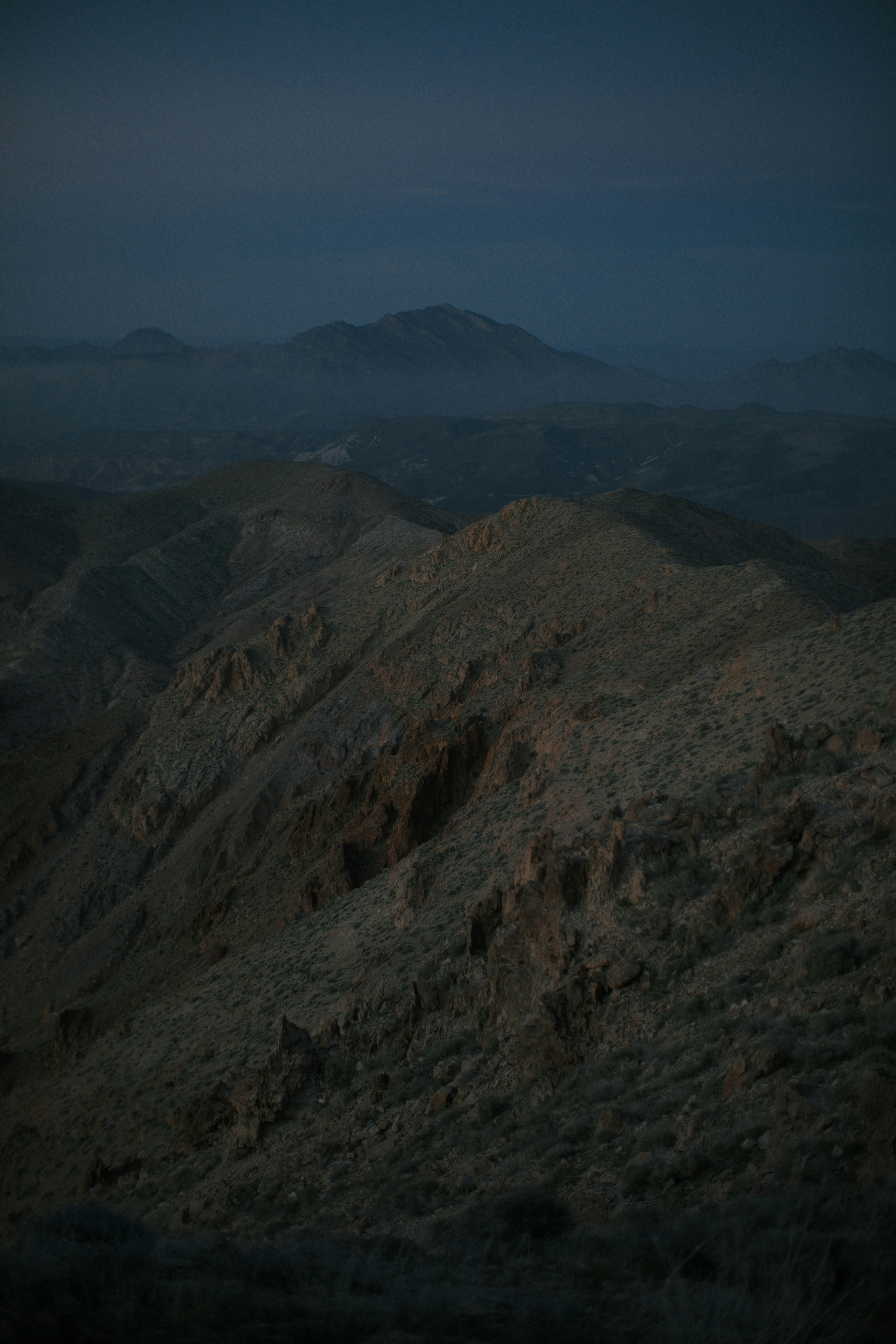 Dusk Over Arid Ridges: A Quiet Descent into Shadowed Valleys