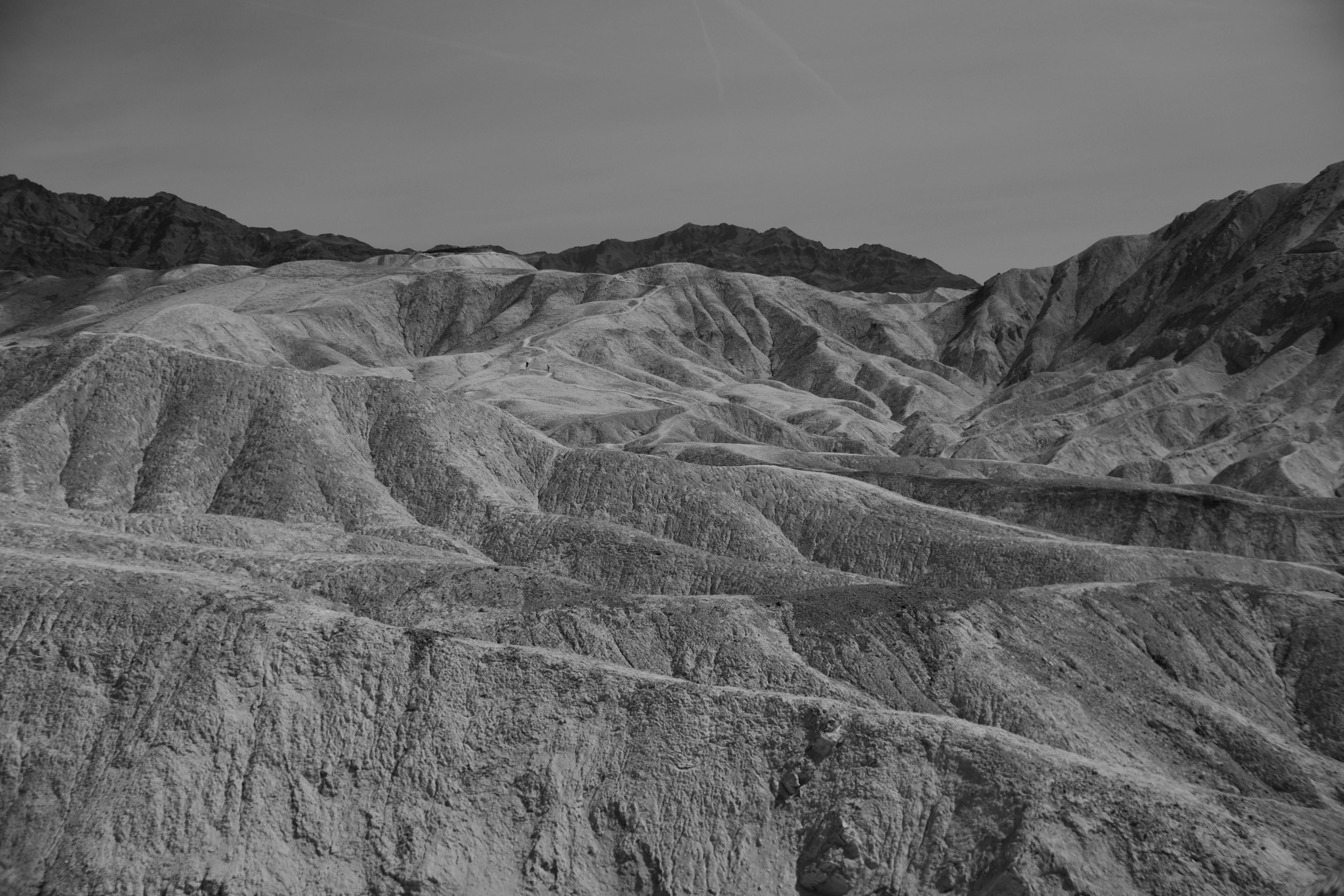 Quiet Erosion: Geologic Ridges under a Pale Sky