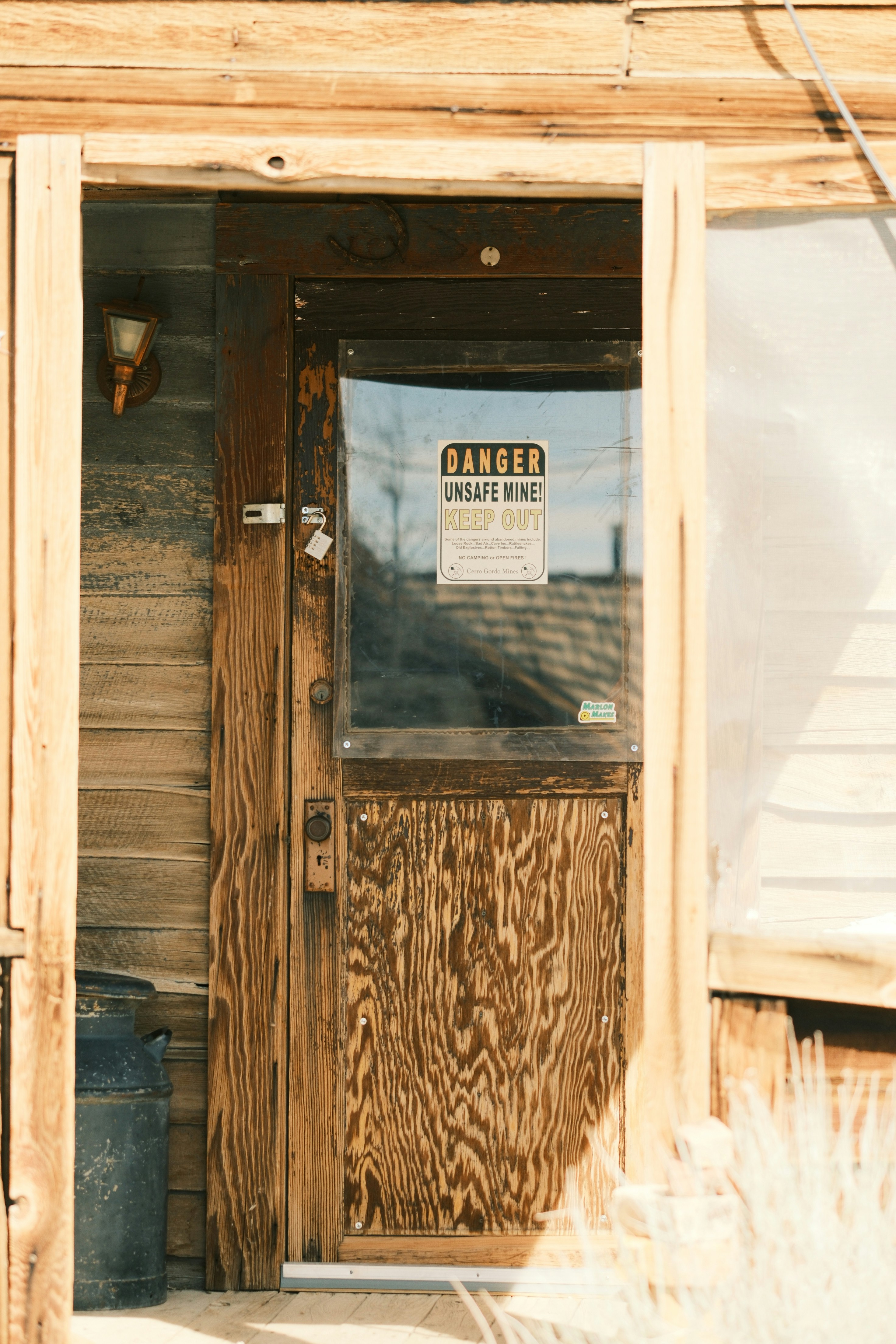 Weathered Doorway with Danger Sign in Warm Rustic Light