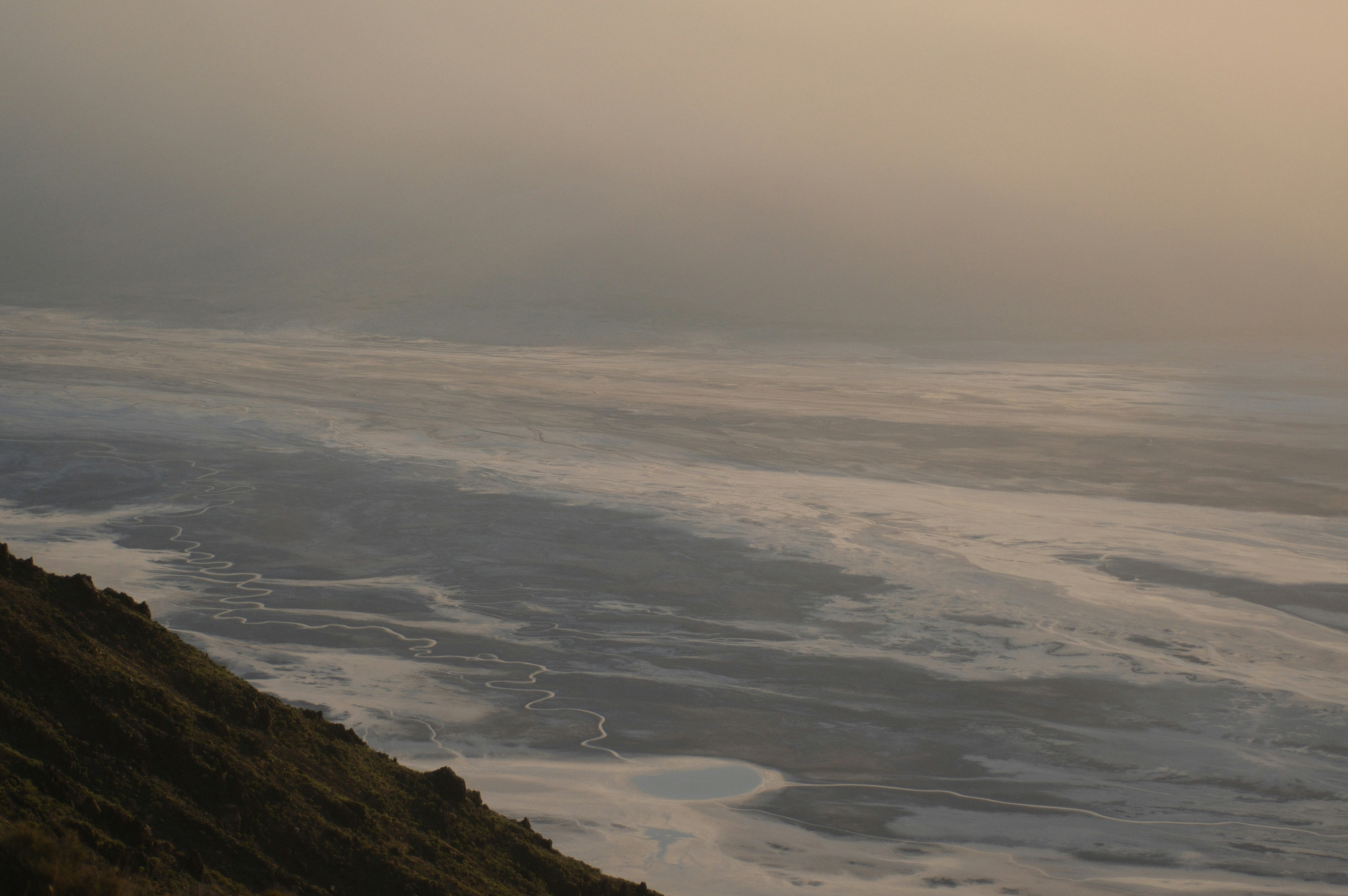 Coastal Ridge Sloping Into a Misty Sea