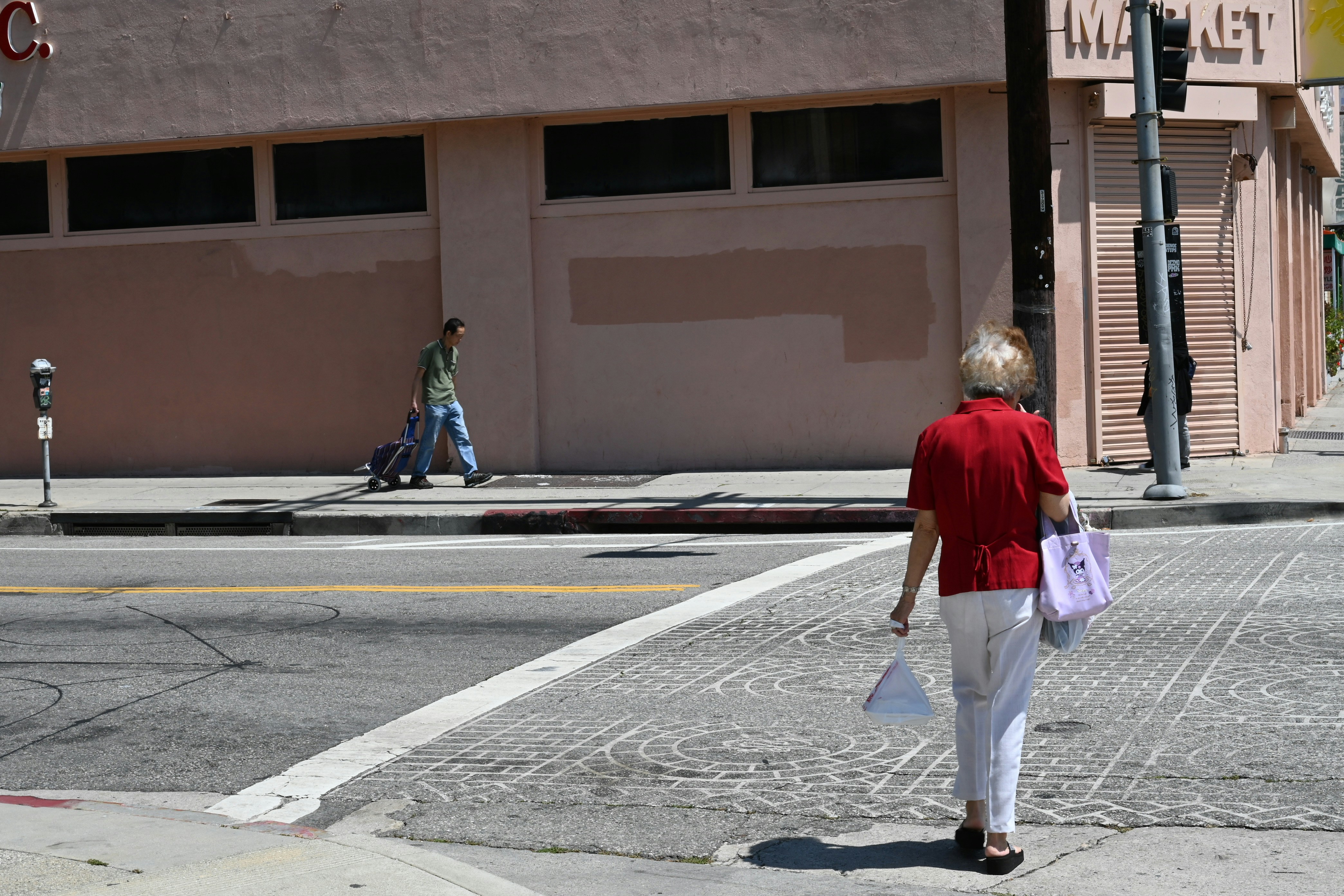 Crossing Paths: A Quiet Pedestrian Moment on a Sunlit Street