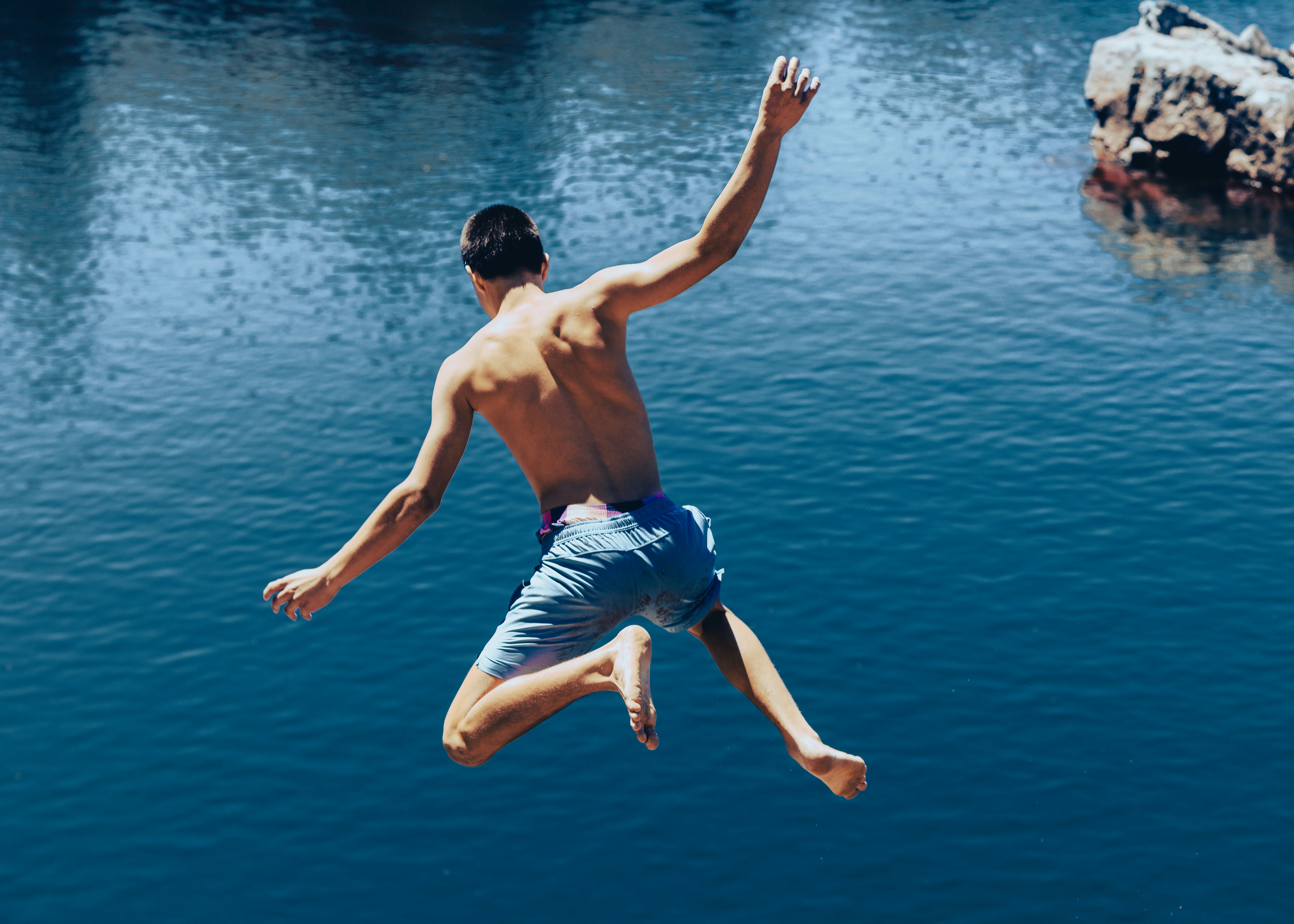 Leap Over Azure Silence: A Summer Jump Across Quiet Waters