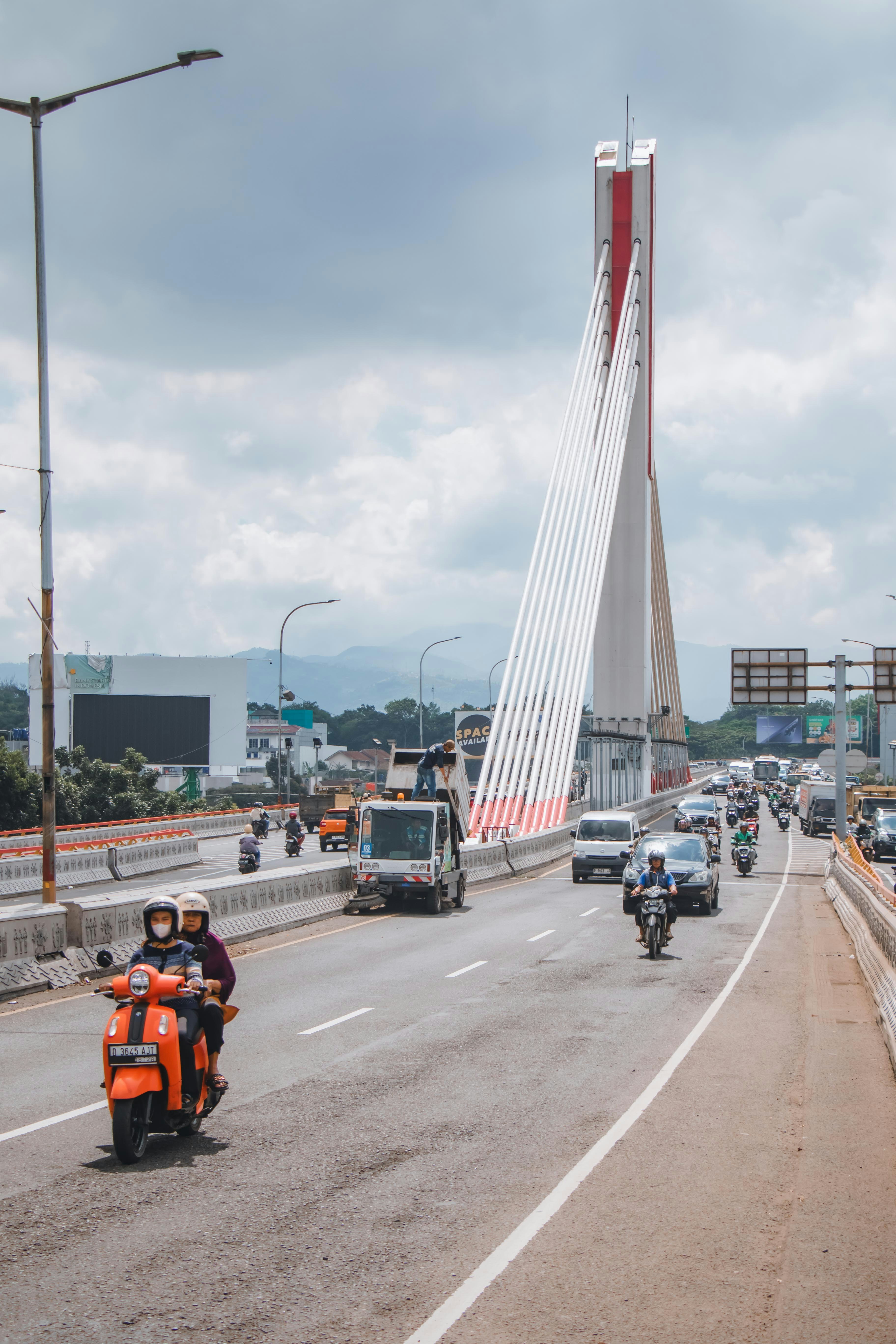 Towering Cable-Stayed Arc: Vehicles Fading into the Horizon