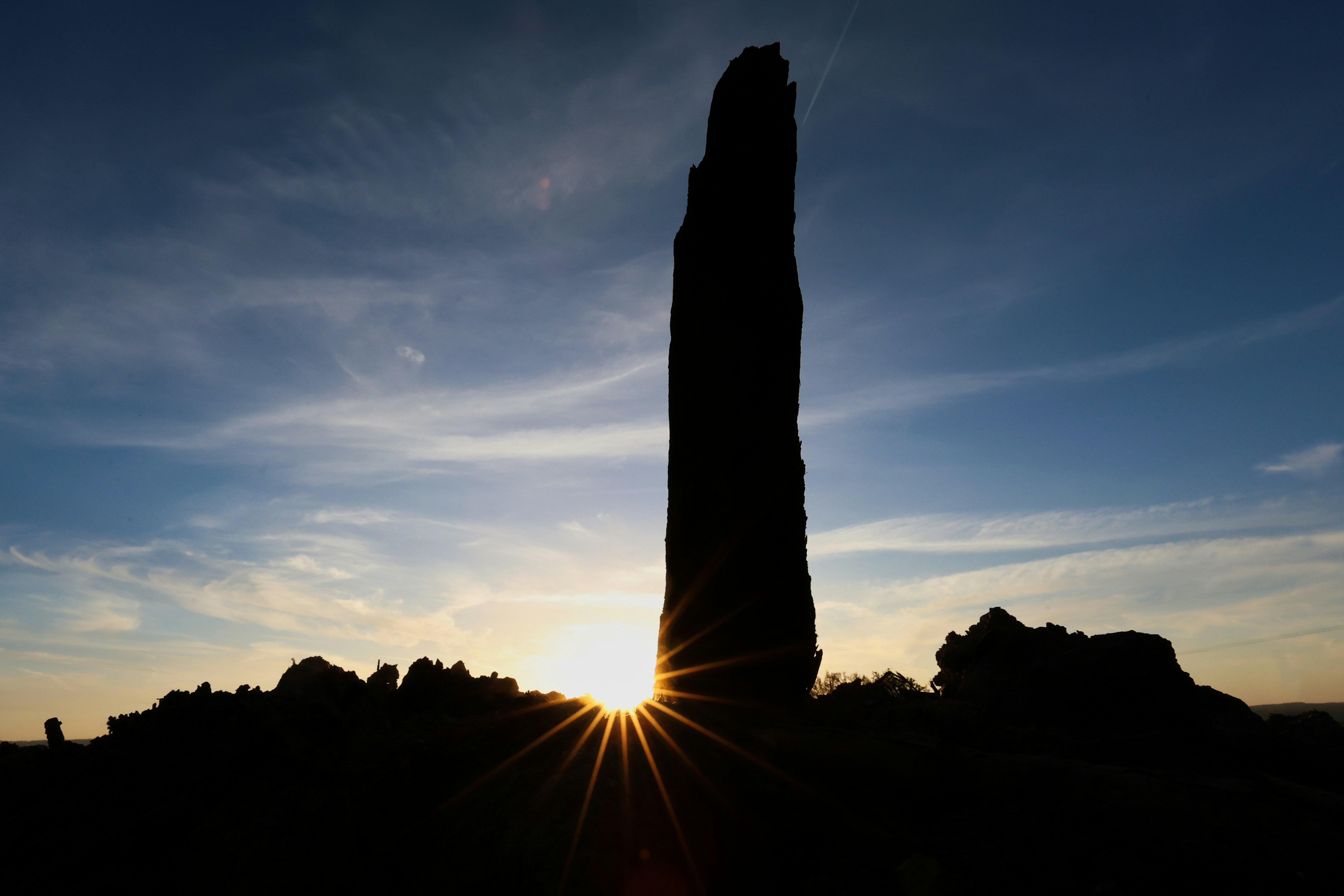 Sunstar Rising Behind a Lone Pillar