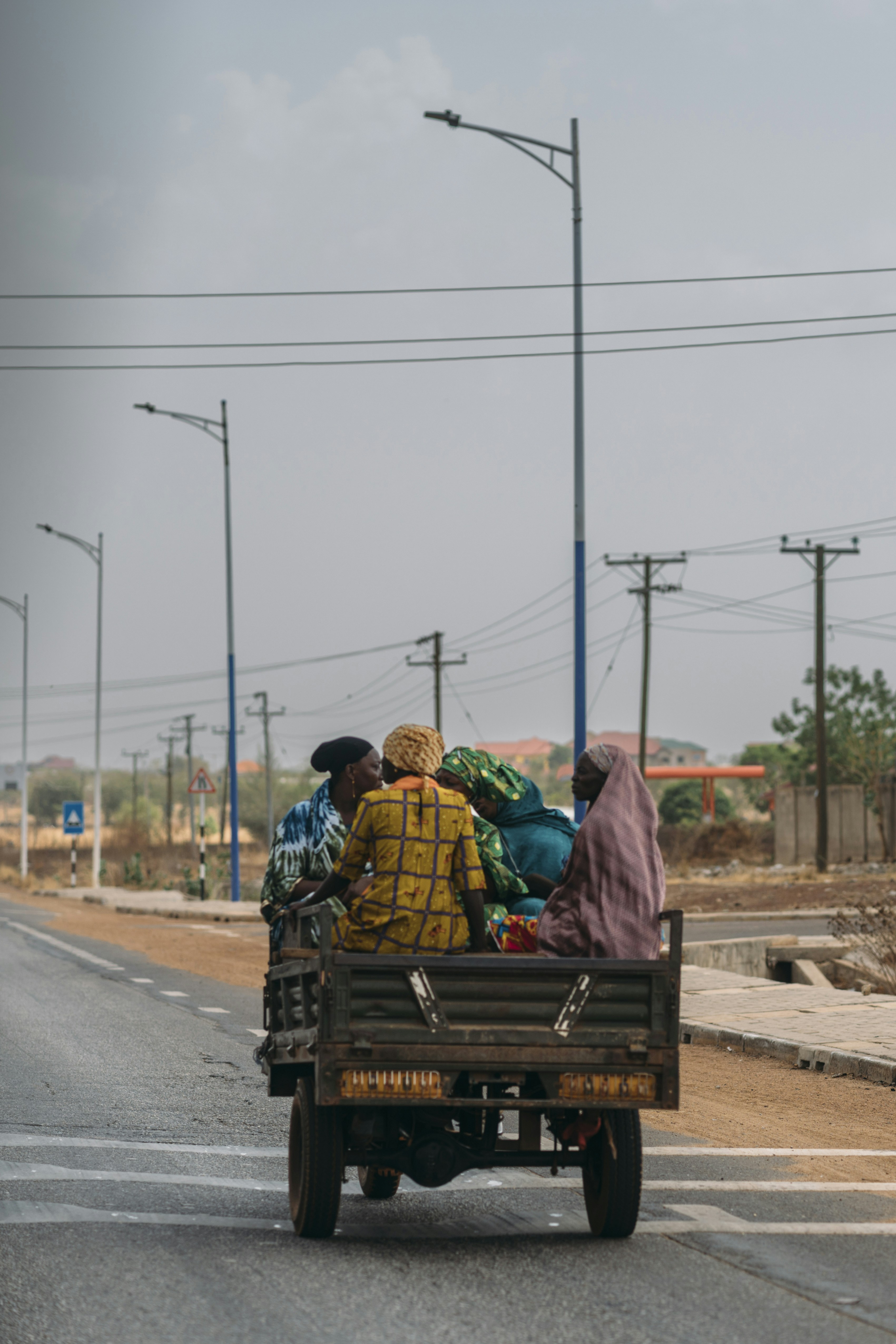 Under an Open Sky: Travelers in a Sunlit Truck Bed