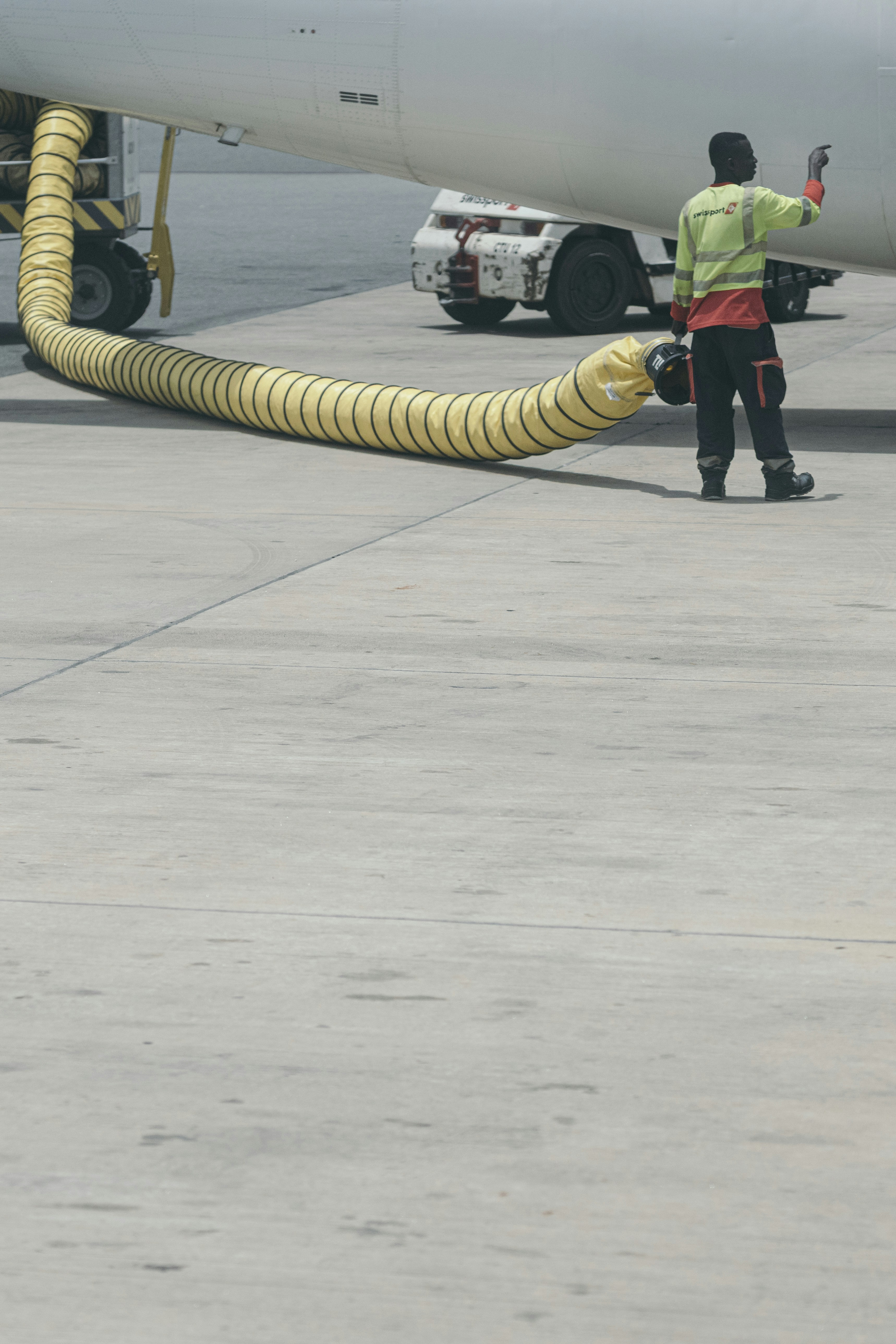 Ground Crew at the Aircraft Hatch: Frayed Hose and Final Prep