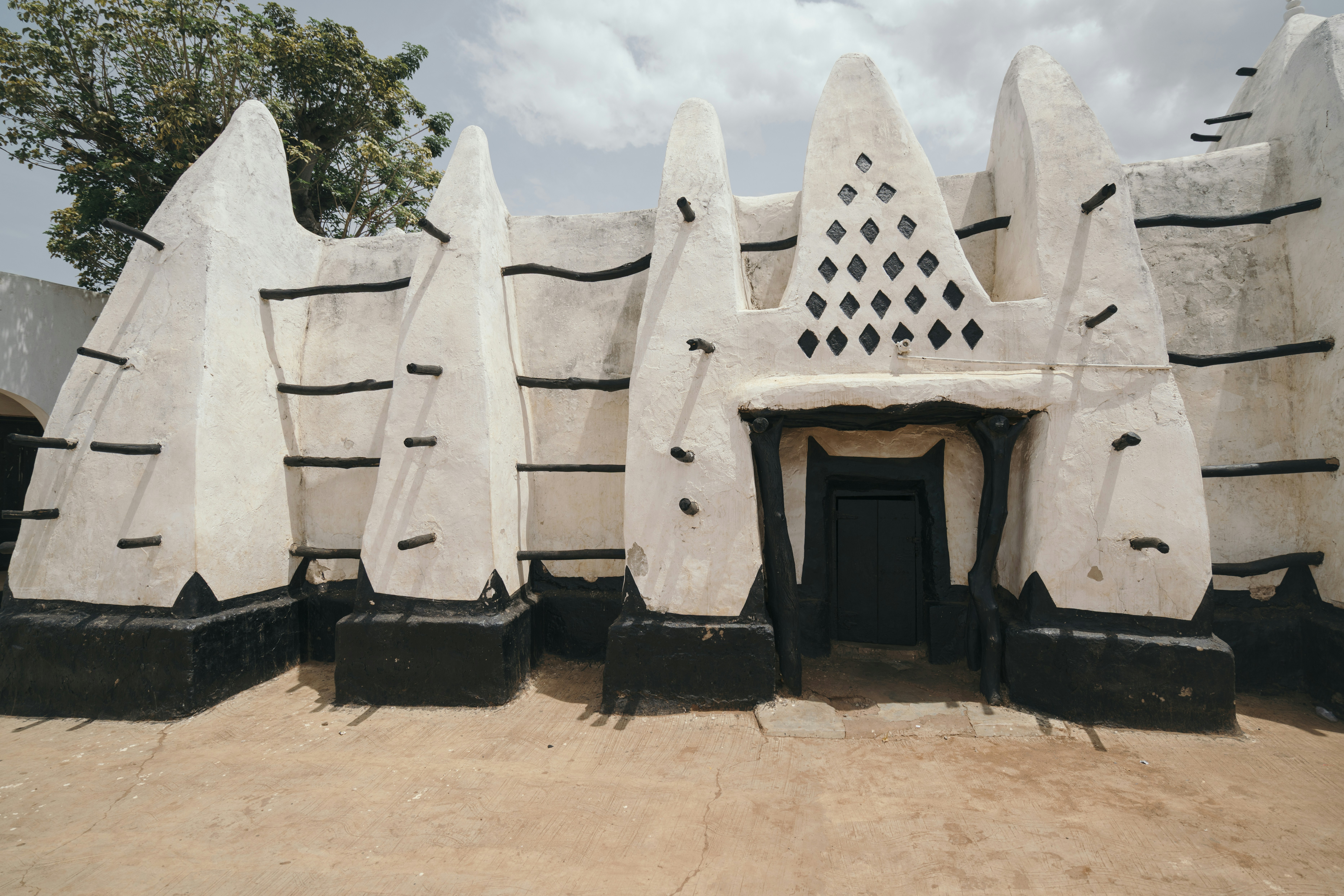 Desert Facade: Adobe Monoliths with Geometric Embellishments