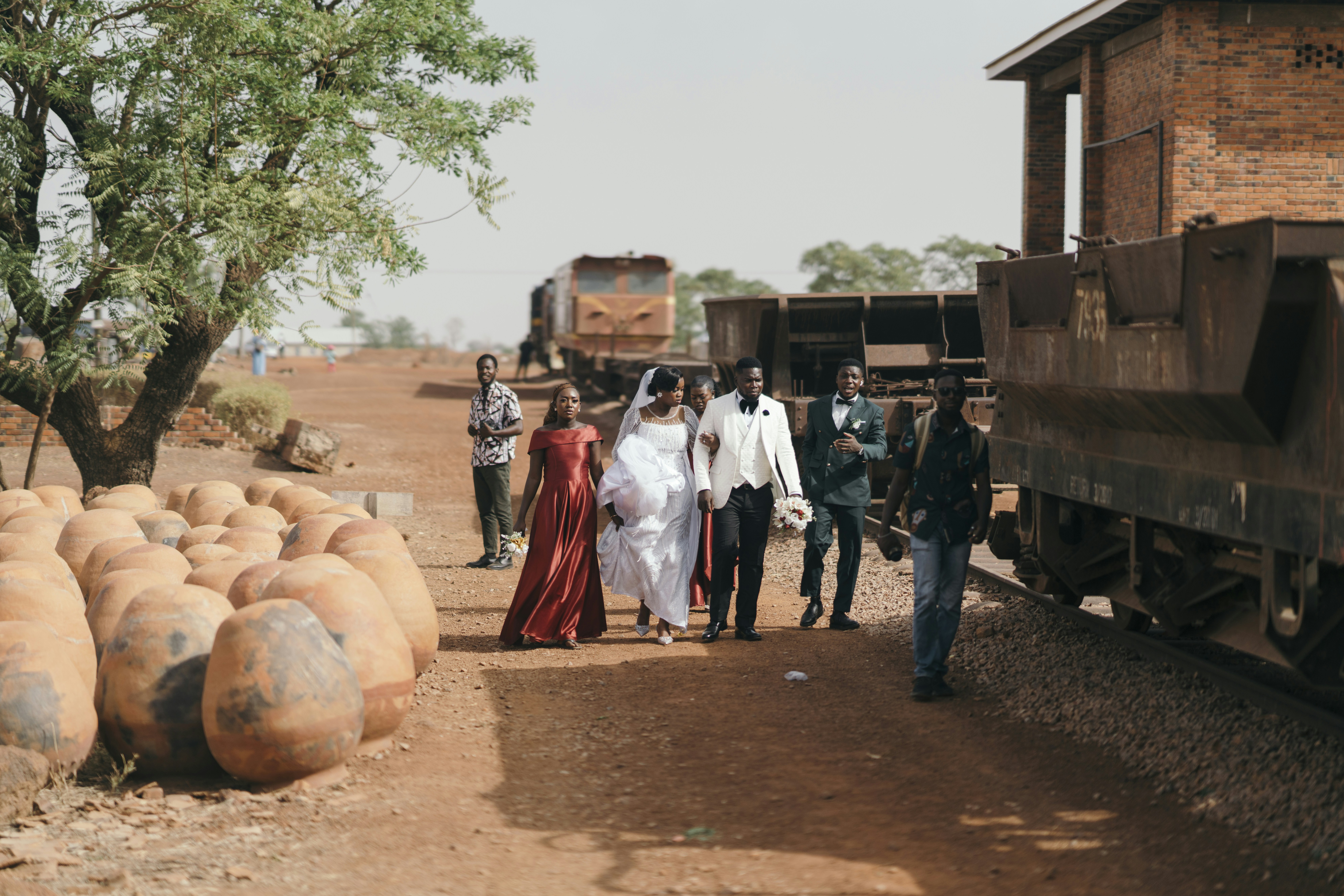 Dusty Railside Wedding: A Bridal Party Steps Toward the Train Yard