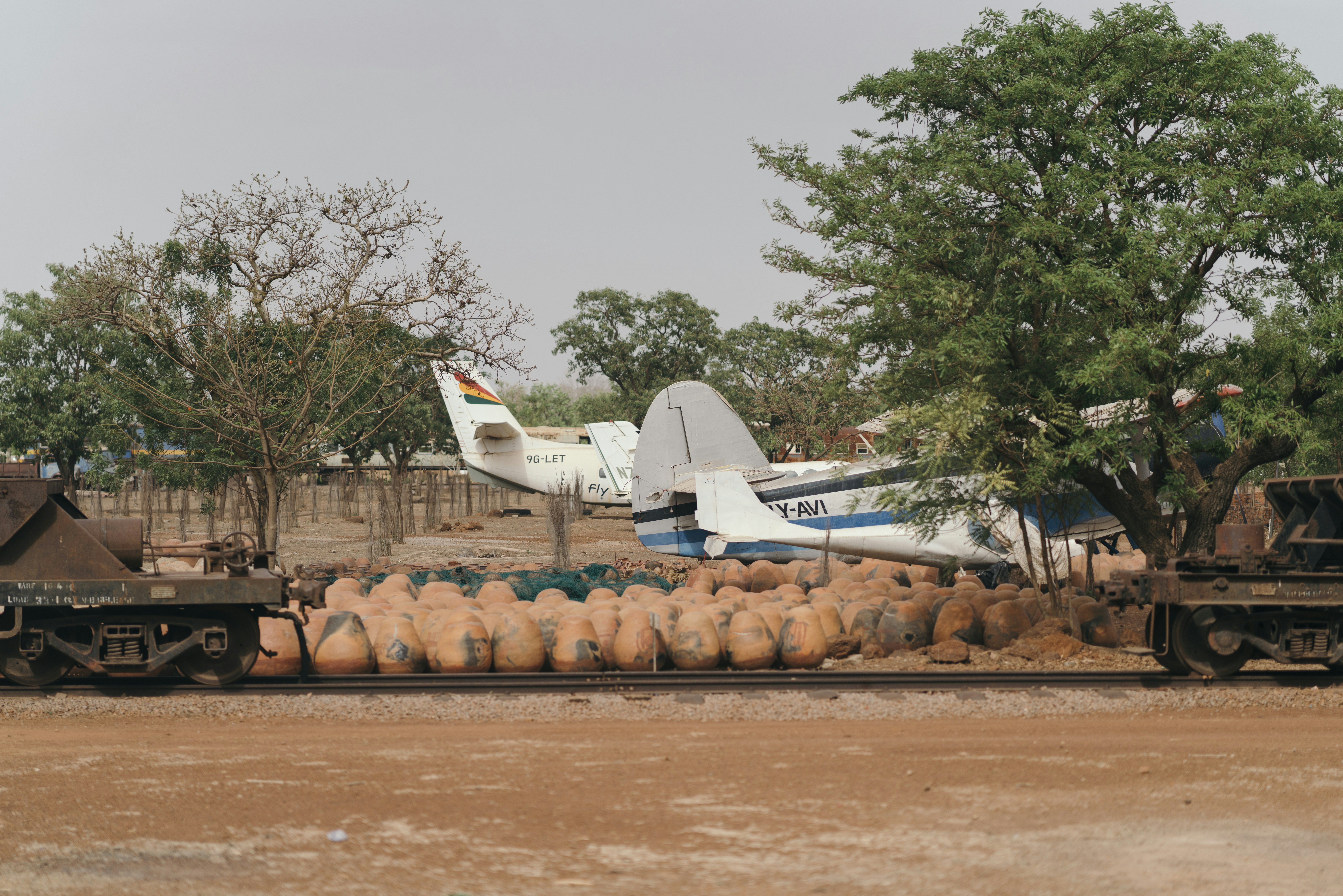 Rusted Runway: A Forgotten Airplane Among Sandbags