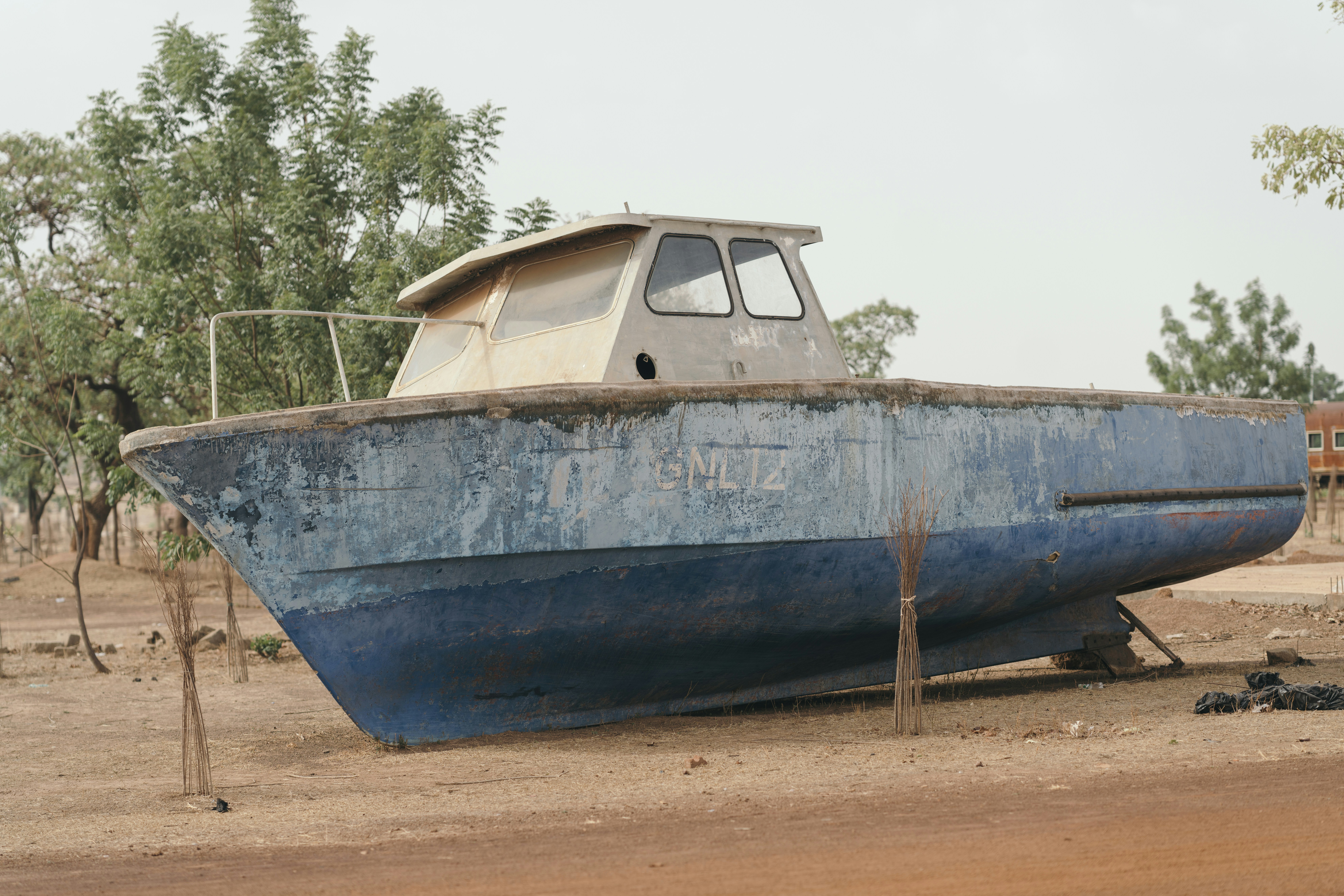 Rusting Blue Vessel Resting in a Deserted Dryland