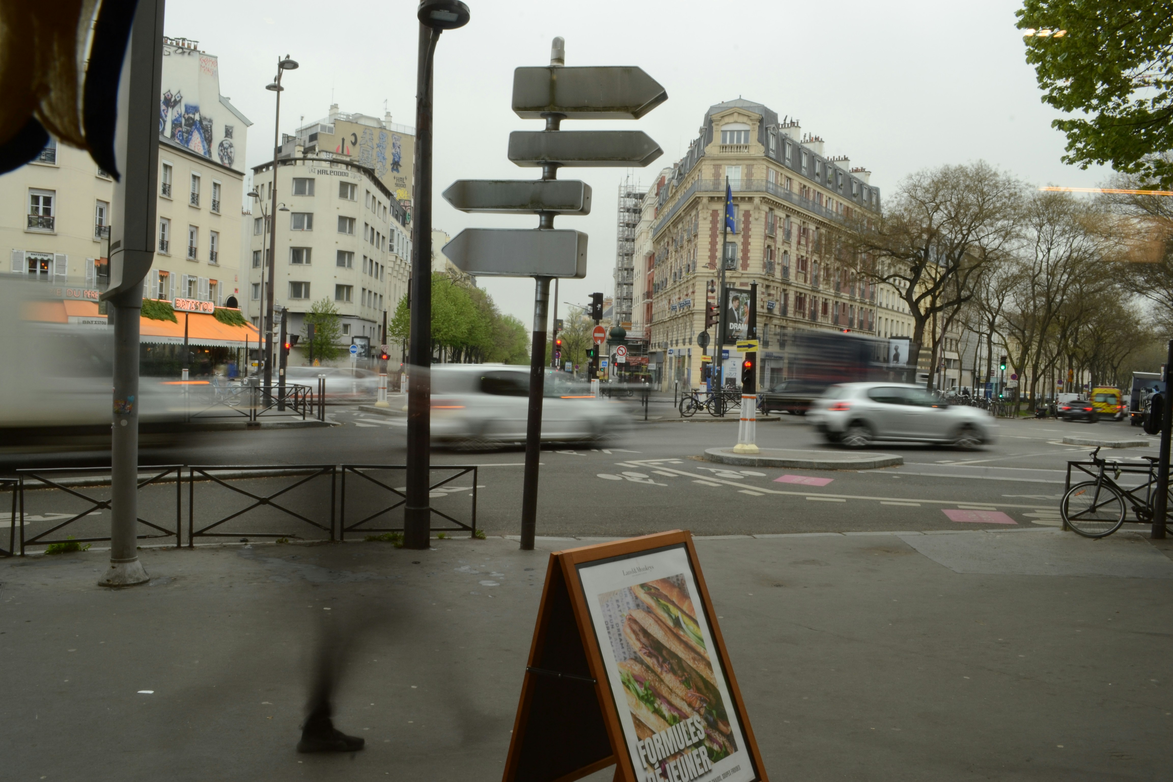 Moving Bow Window: Street Blur and a Menu Board in Paris