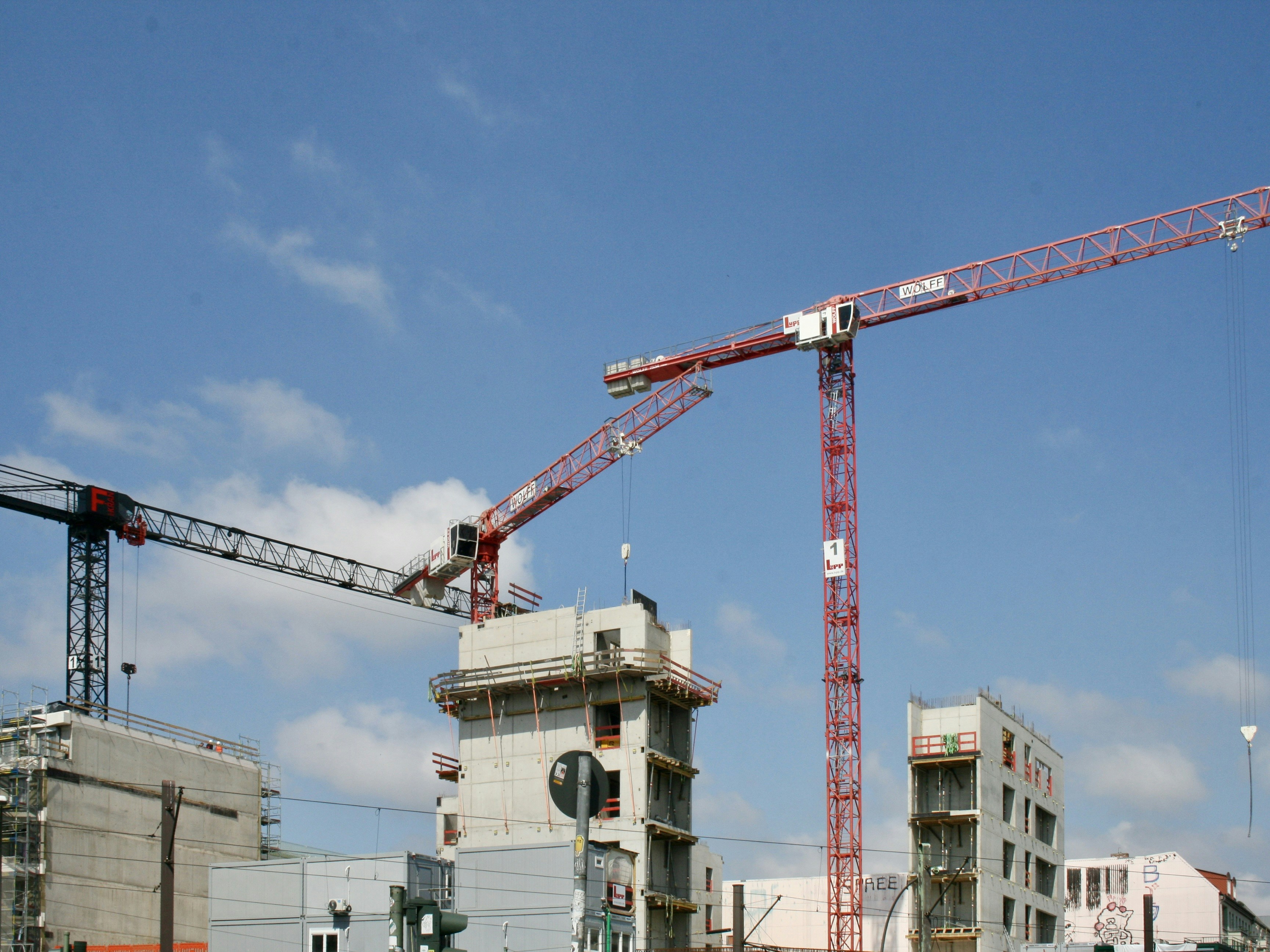 Crane Ballet Over a Concrete Skeleton
