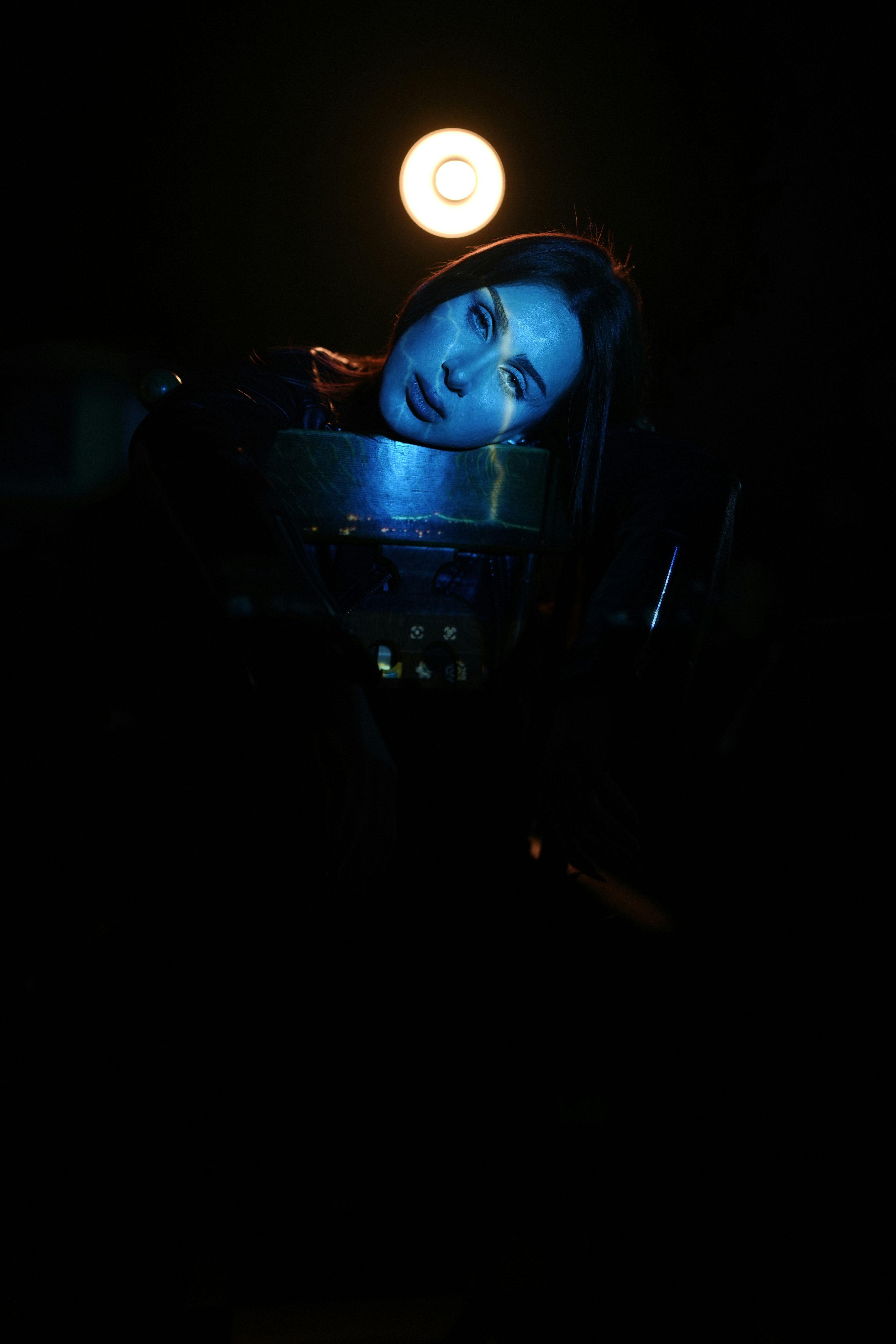Blue-lit Portrait in a Night Studio Chair