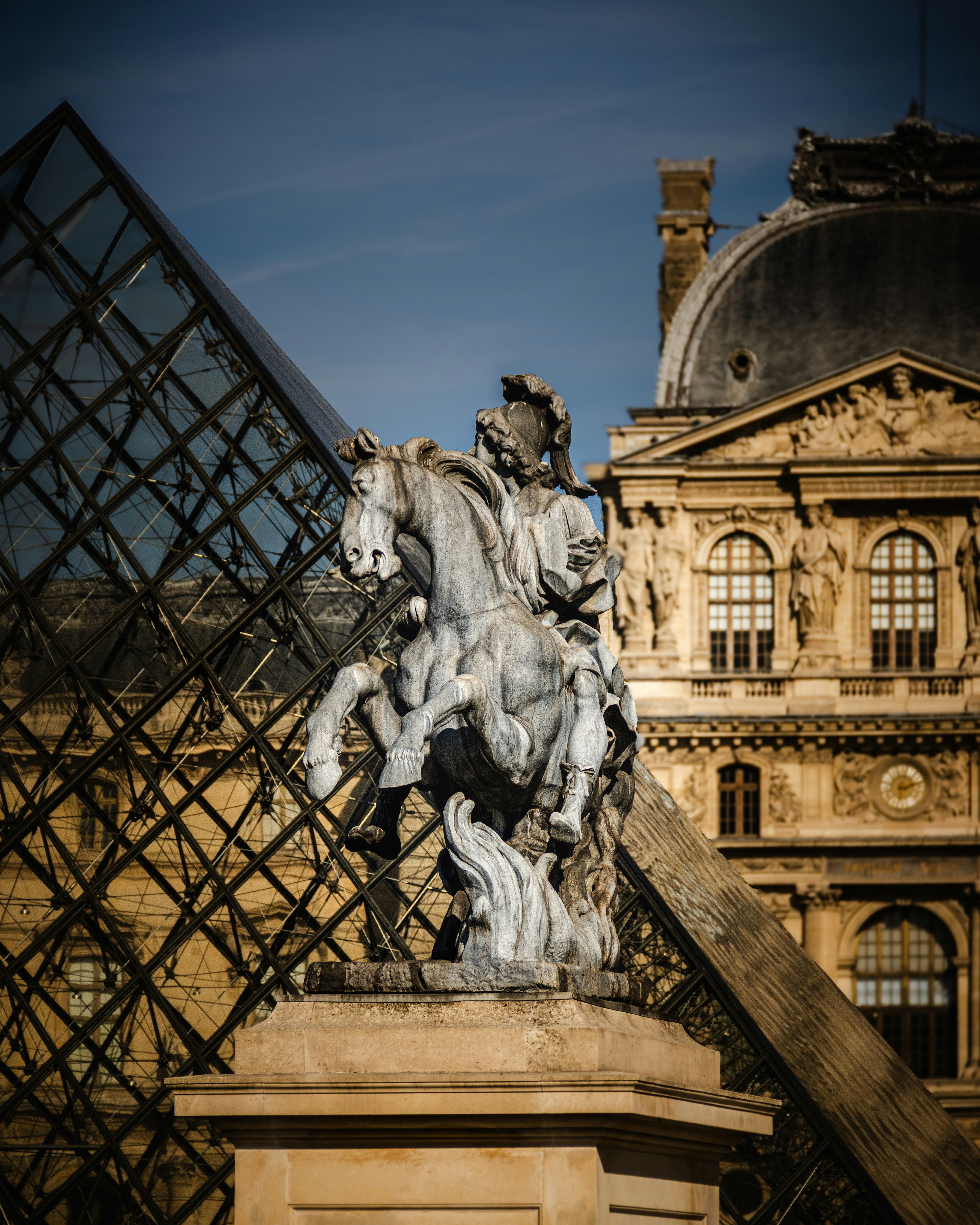 Equestrian Stone: A sculpture framed by glass and history beneath the Louvre