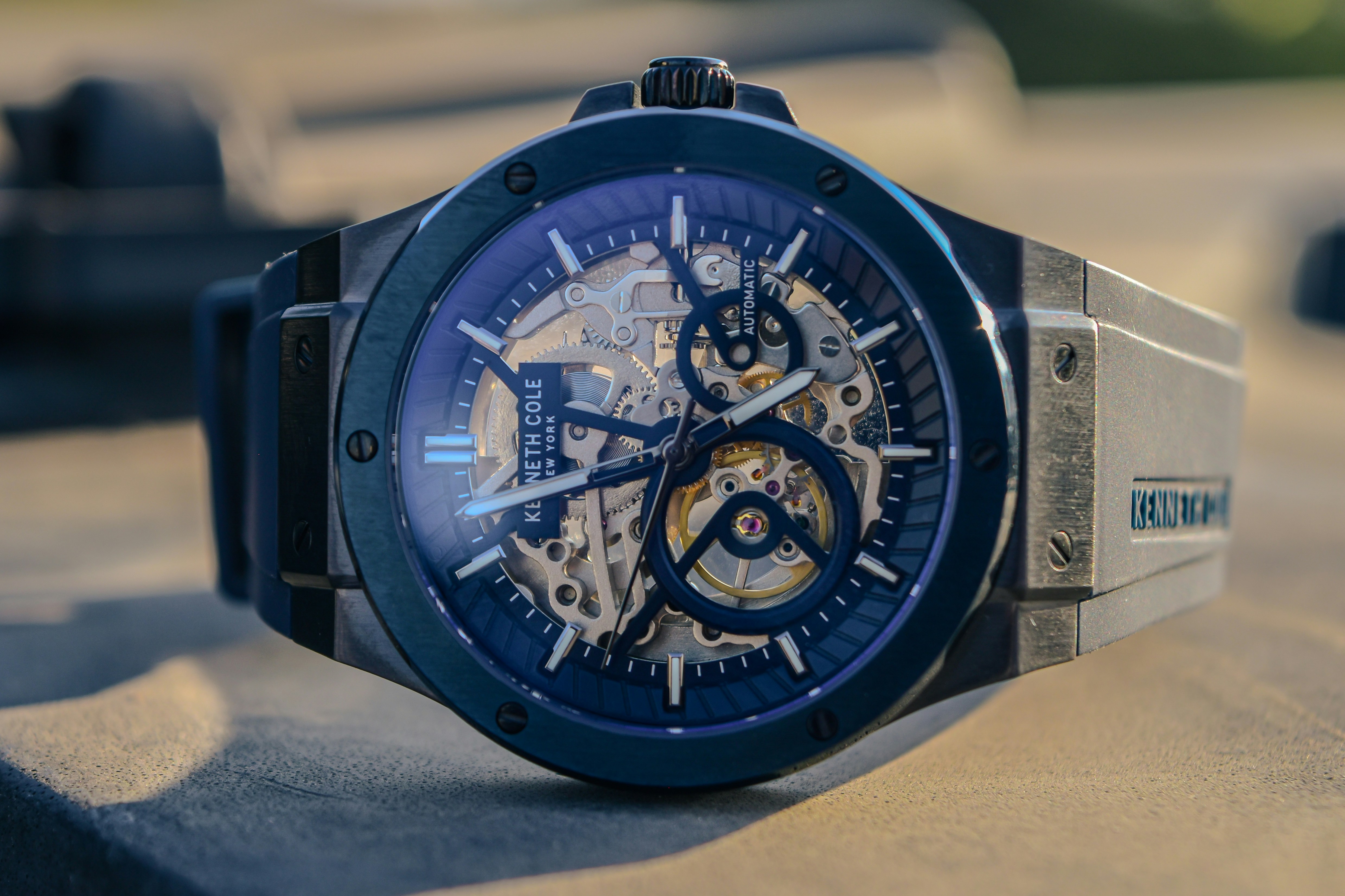 Mechanical Eye: A Skeleton Watch Resting on Sand