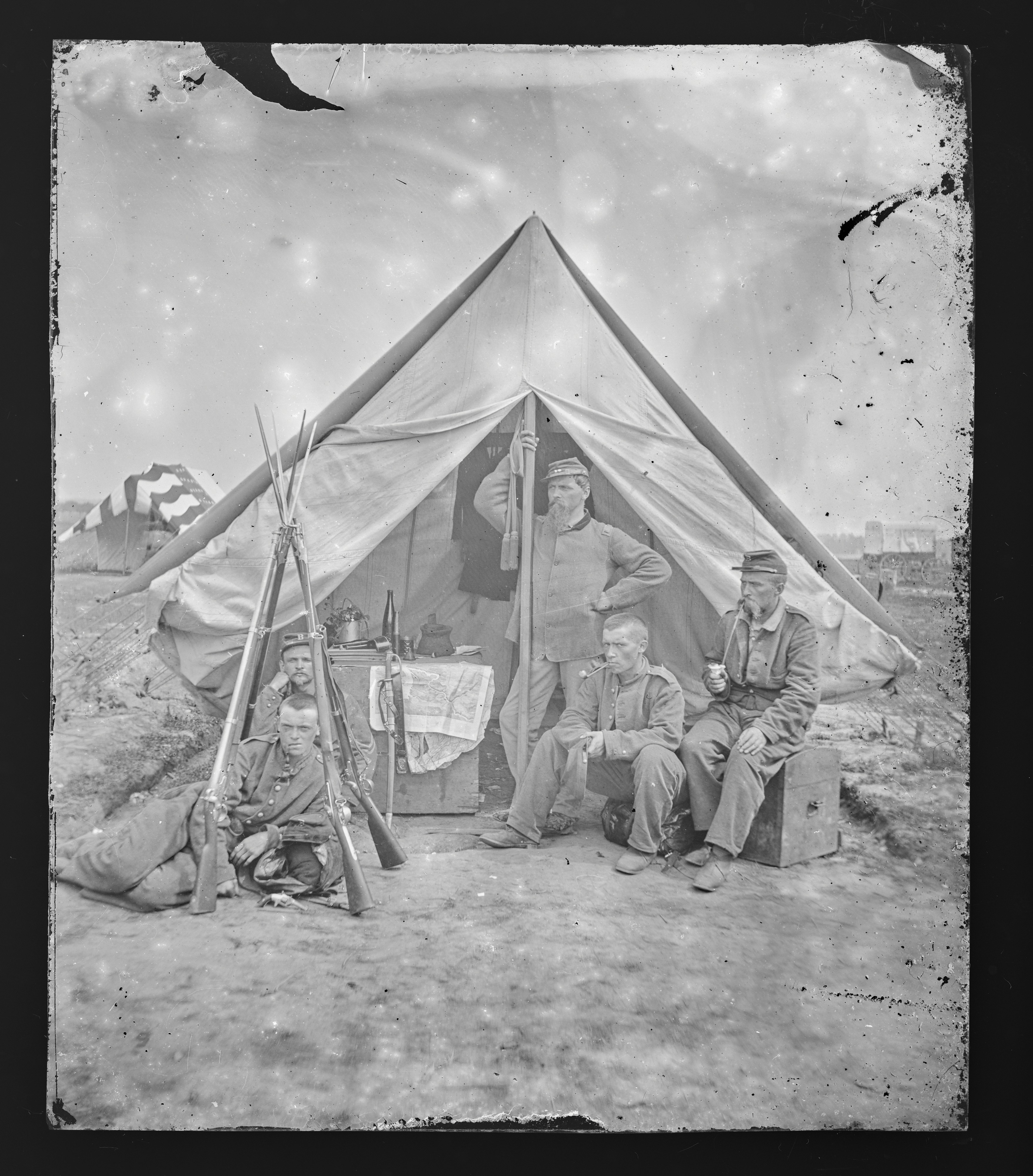 Camp Scene Under a Cone Tent: Soldiers Relax at Dusk
