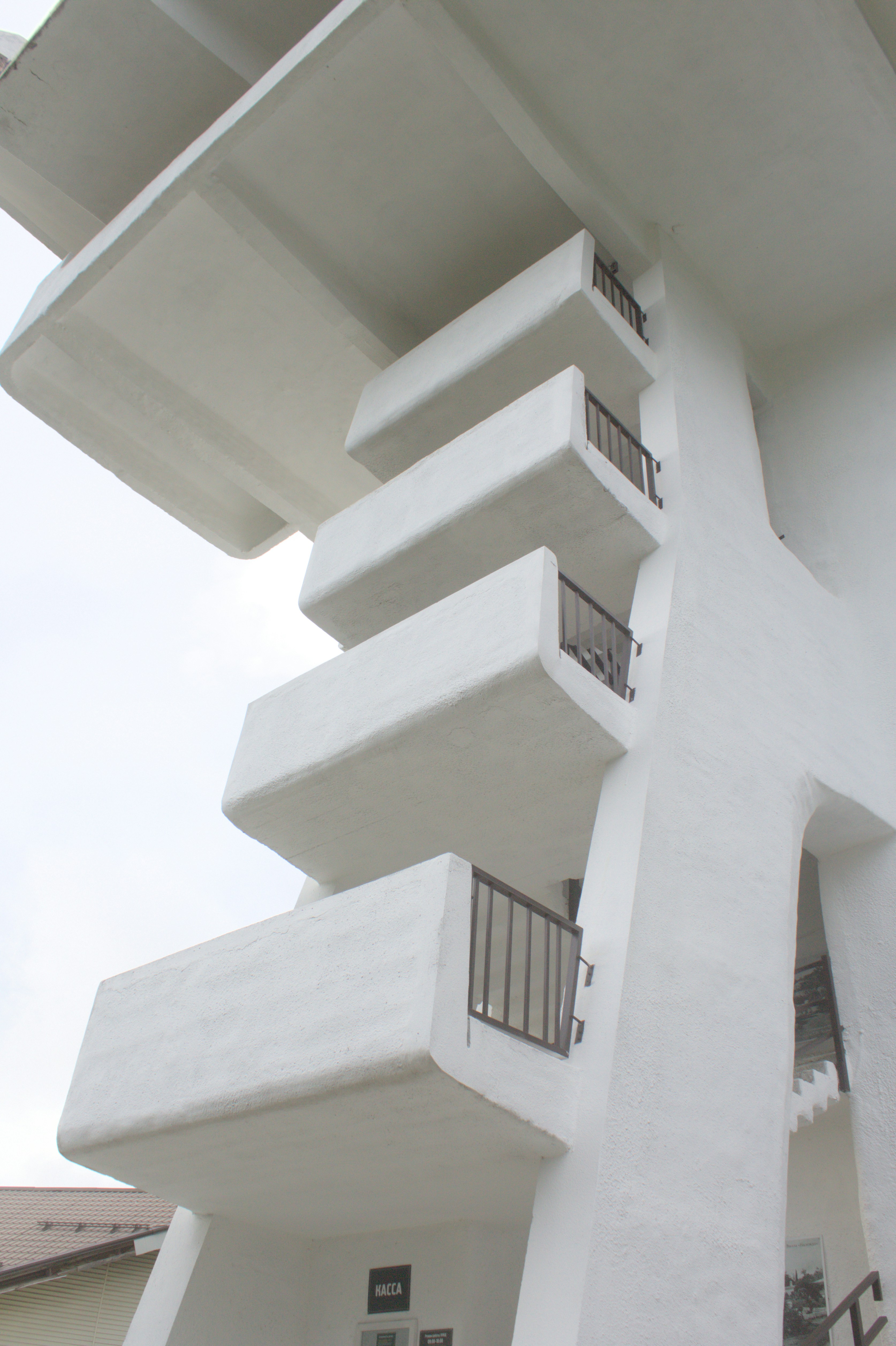Winged Concrete: A Vertical Stairway to Light in White Geometry