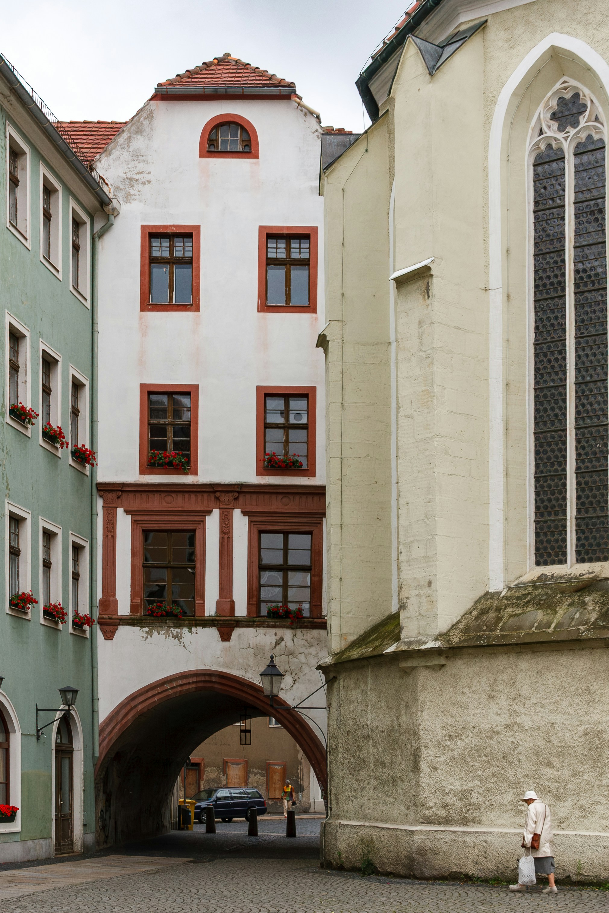 Narrow Passage Under the Arch: A Quiet Moment Between Buildings