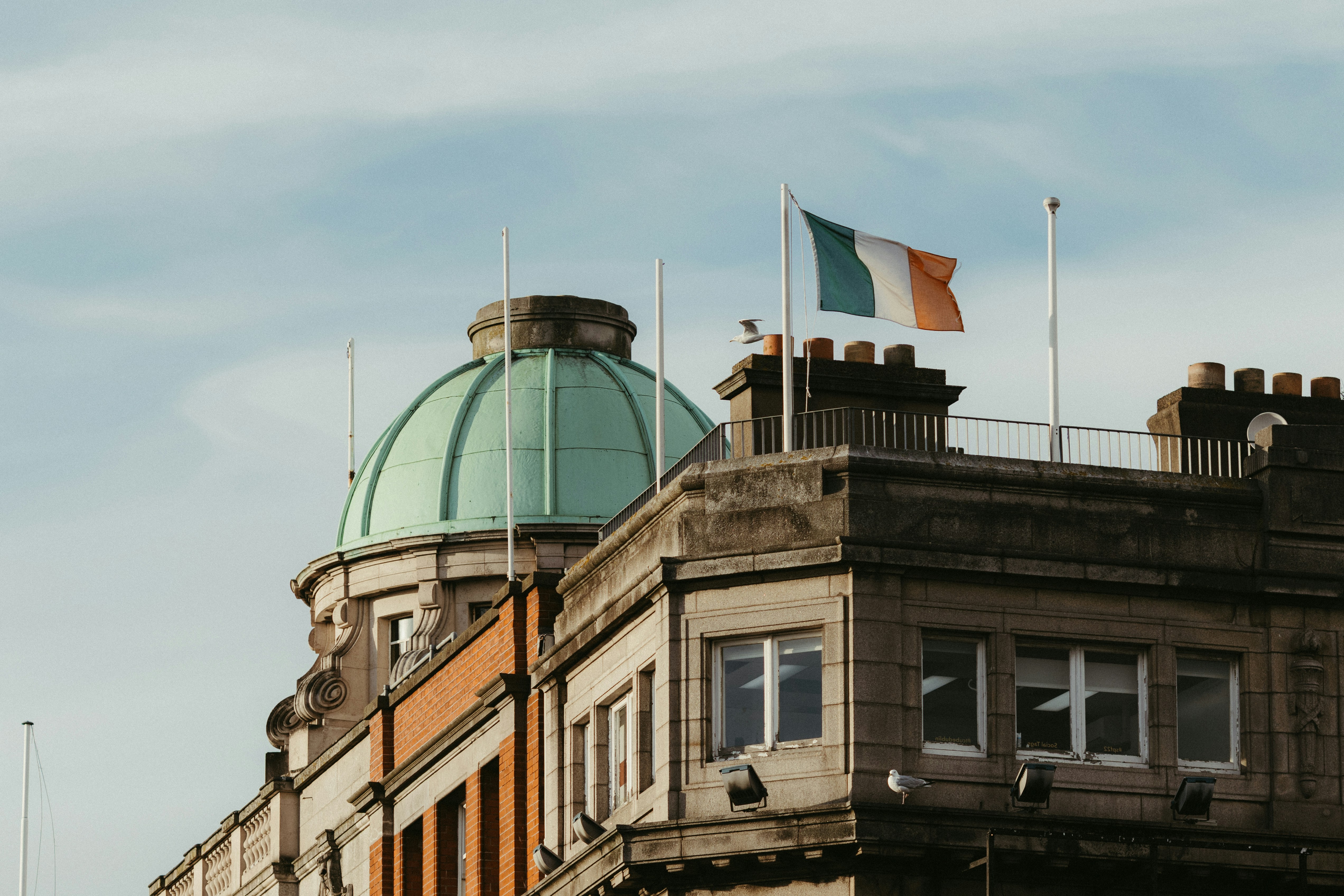 Flag Above the Dome: Irish Tricolor on a Classic Rooftop