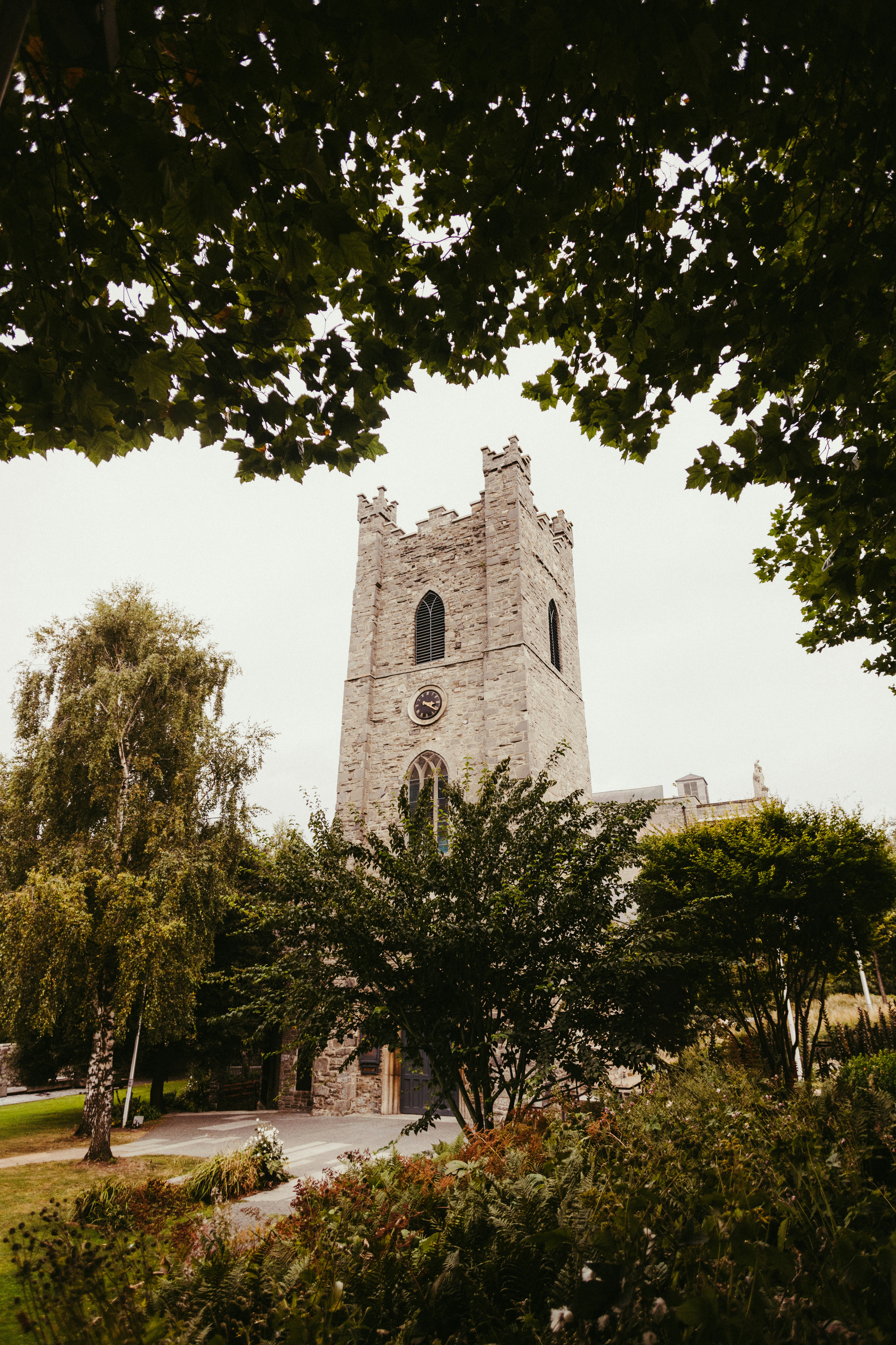 Stone Tower Rising Above a Quiet Garden Arc
