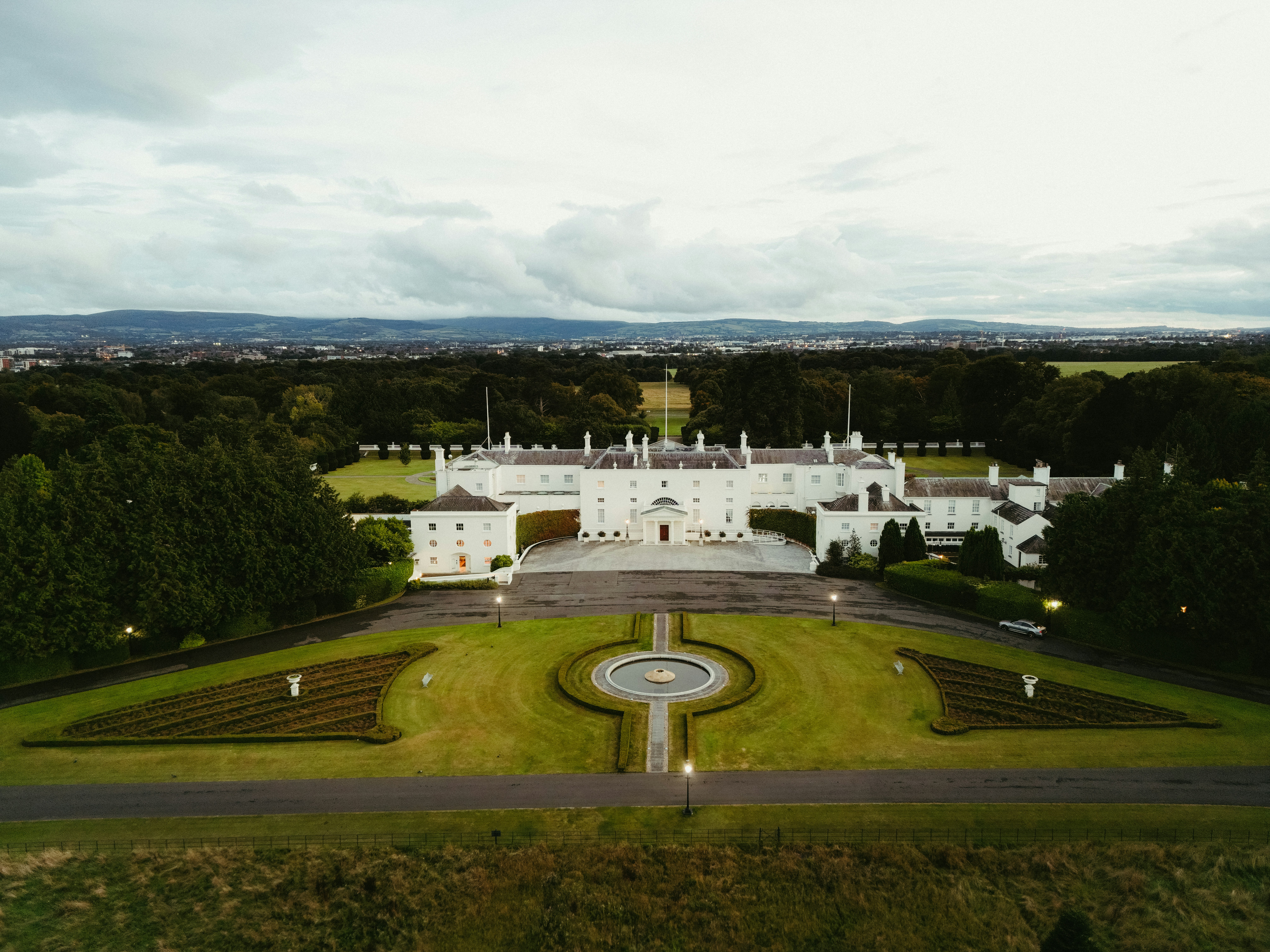 Symmetrical Palace Grounds Framed by Greenery and Sky