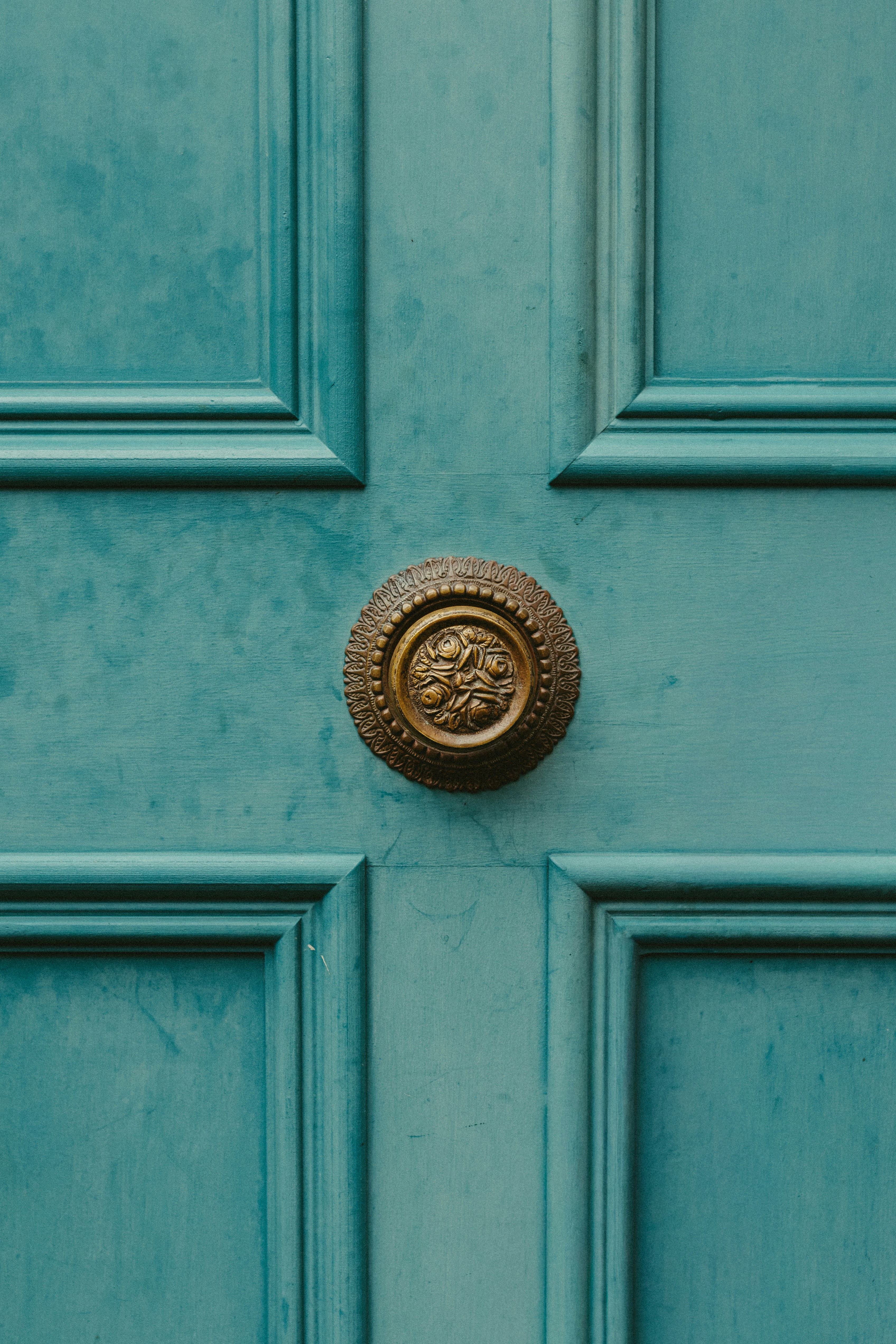 Aged Turquoise Door with Ornate Brass Knob