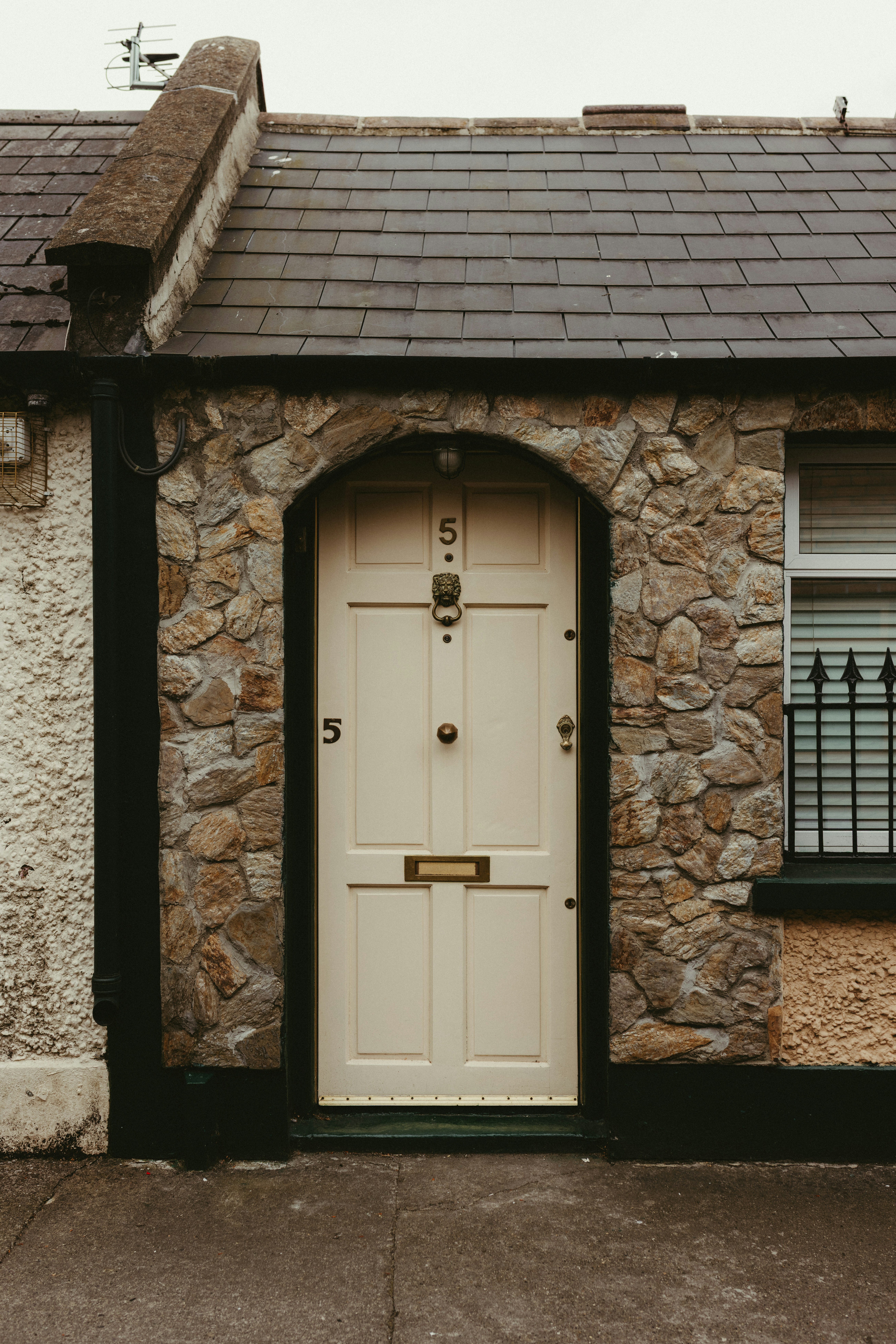 Stone-arched Front Door in Ringed Cottage