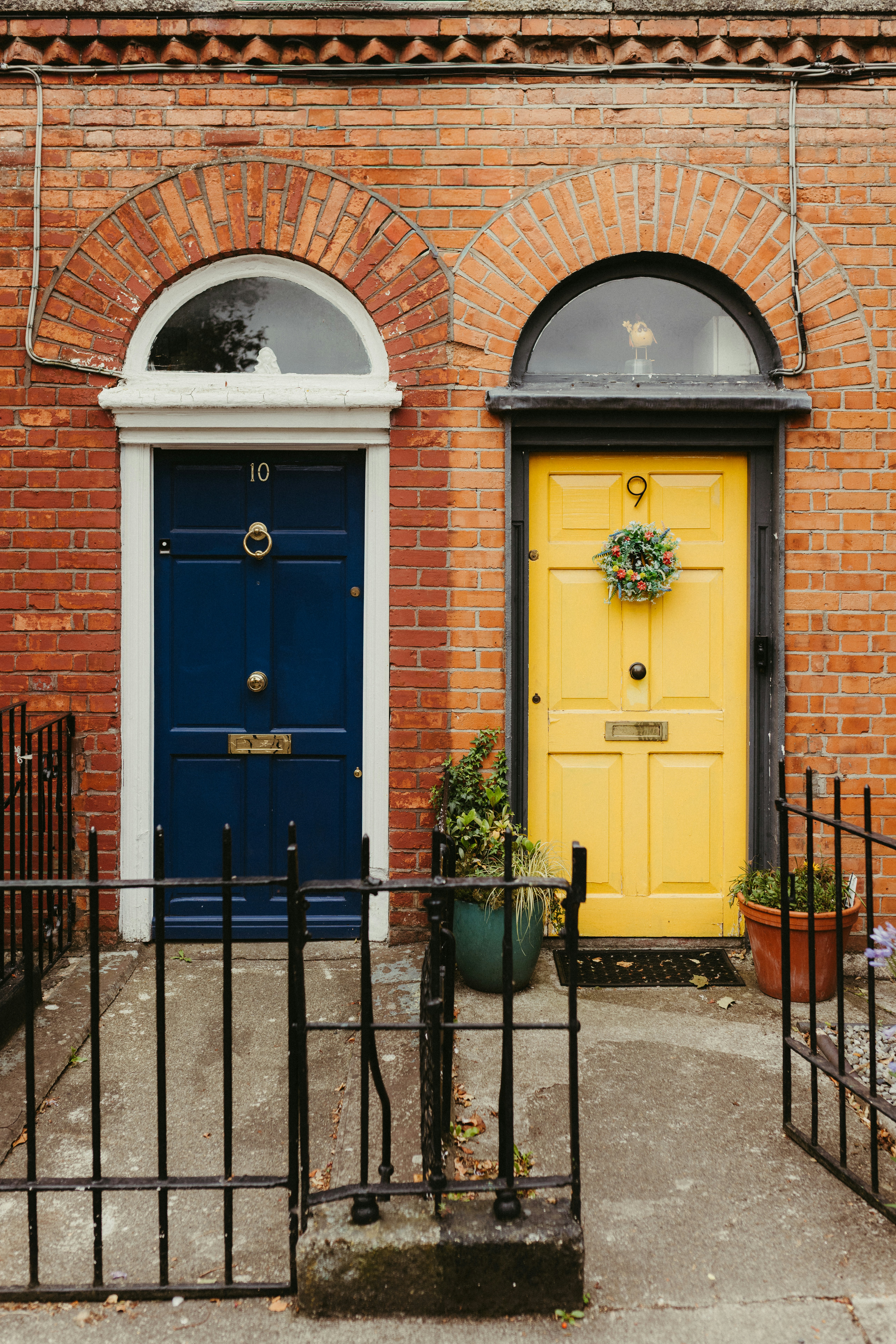 Two Doorways, One Street: A Colorful Quiet in Red Brick