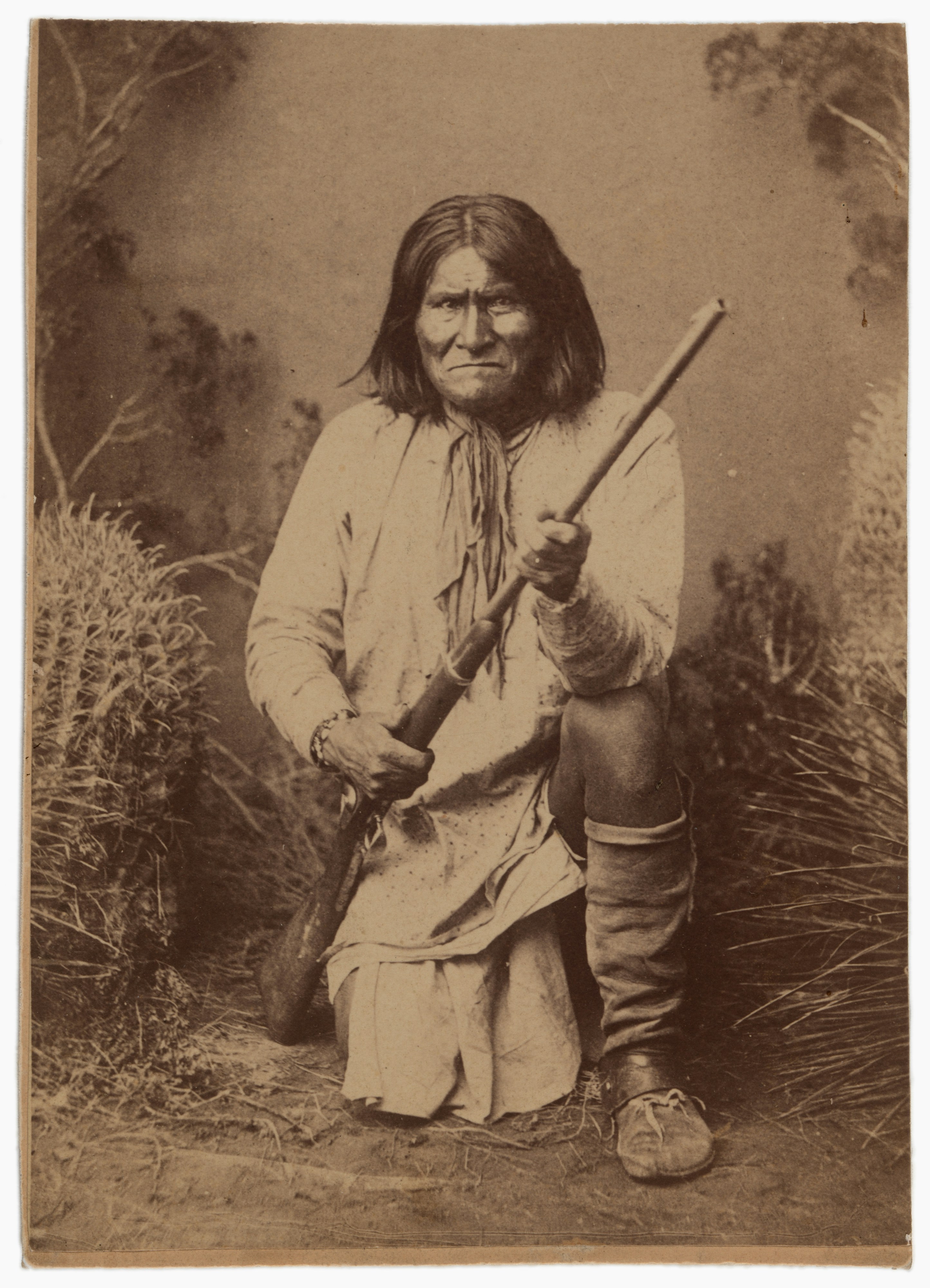 Frontier Chief with Rifle: A Humble Portrait in Sepia