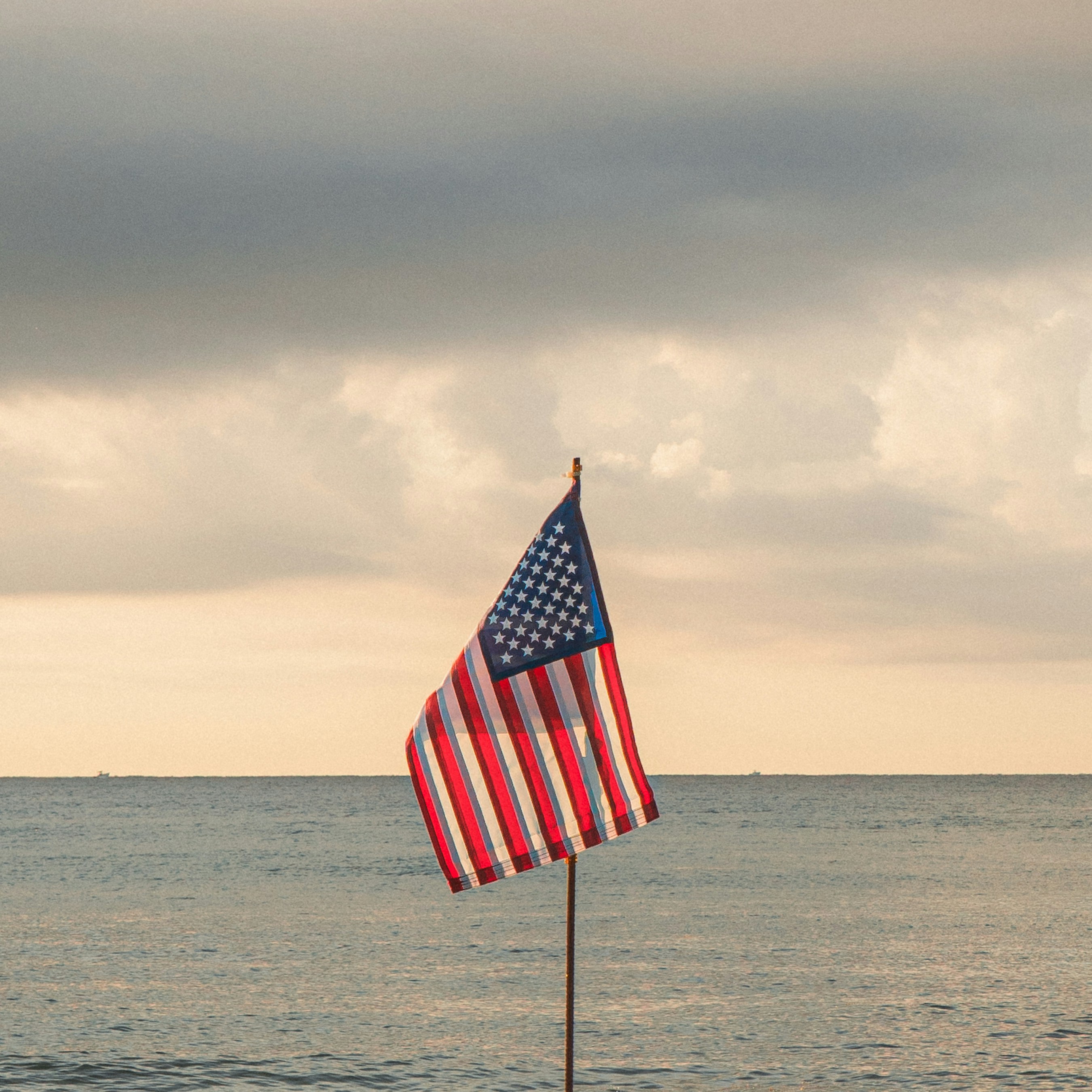 Flag on a Quiet Horizon: An American Emblem Over the Sea