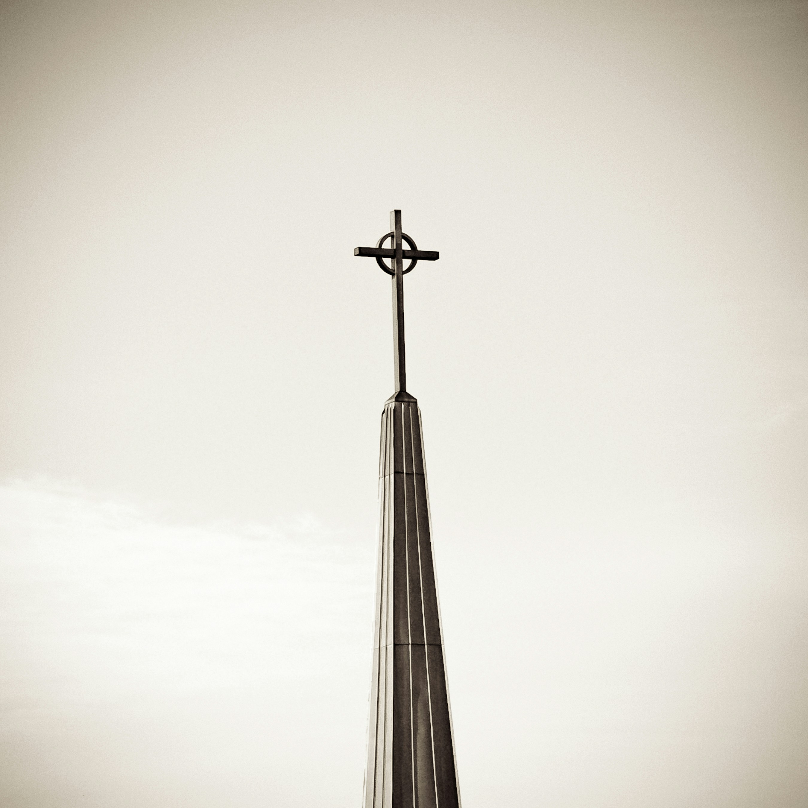 Crowned Spire: A Lone Cross Reaching Skyward