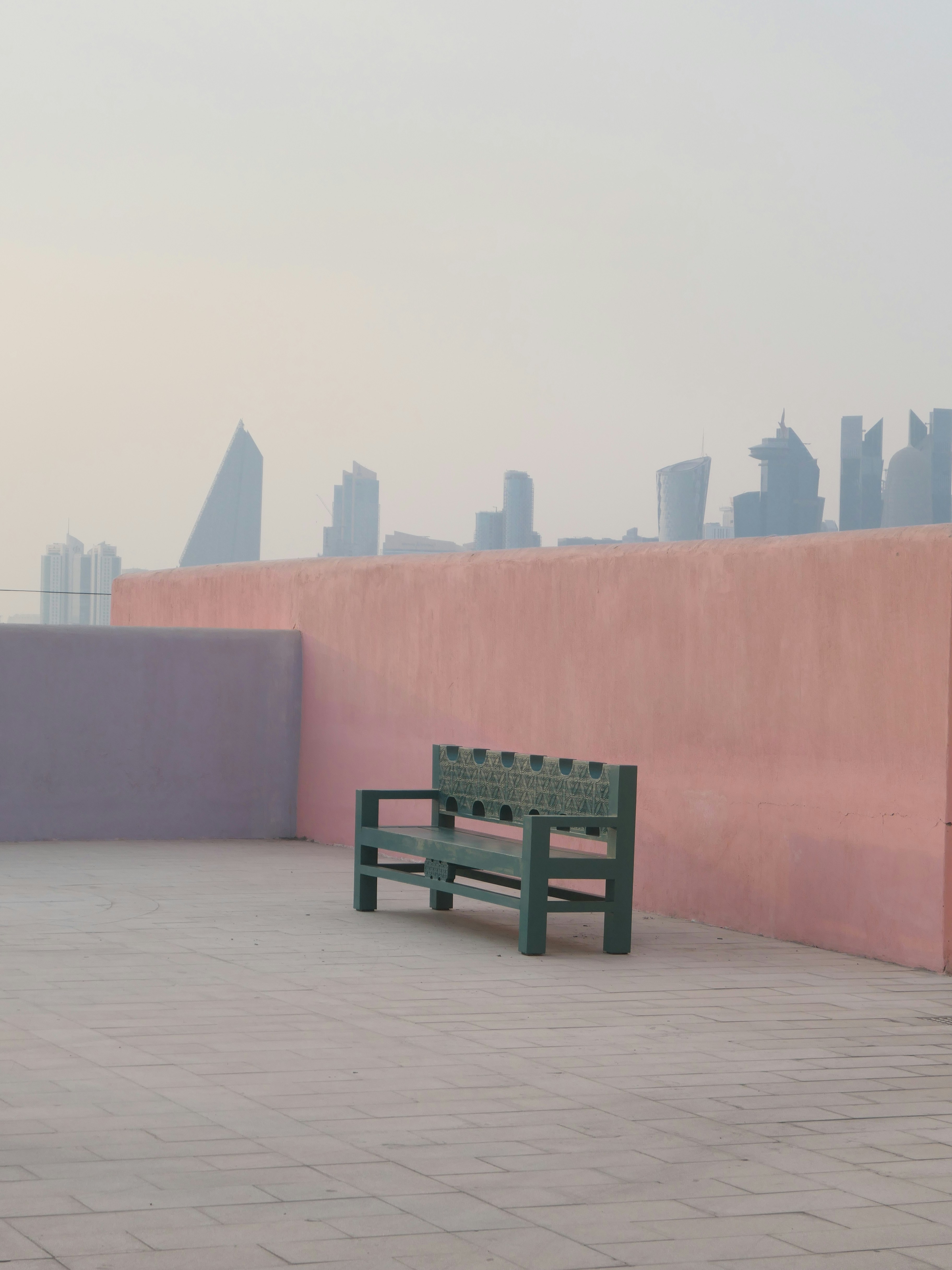 Montserrat on a Terrace: A Quiet Moment with a Green Bench