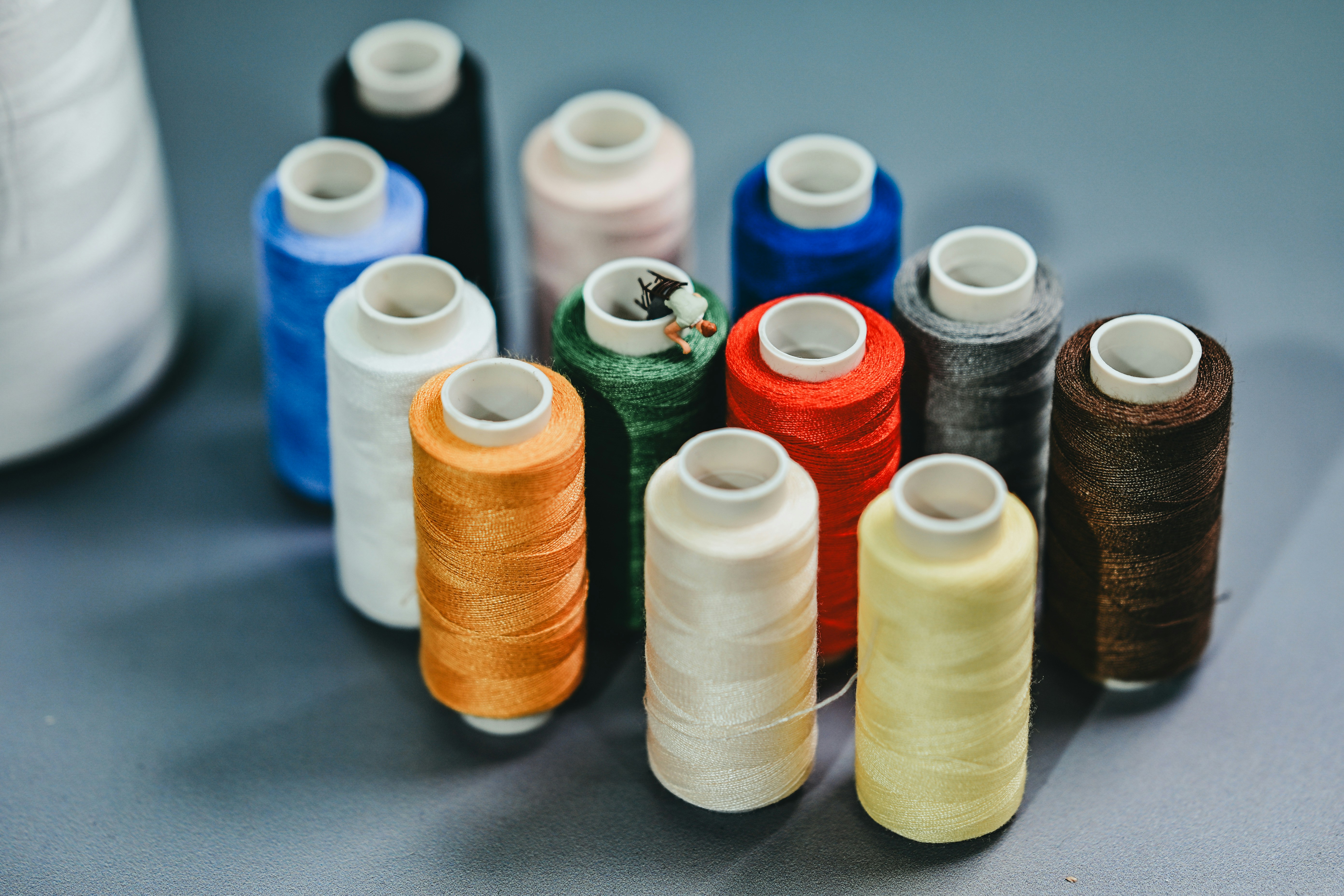 Threads of Color: A Row of Spools in Soft Studio Light