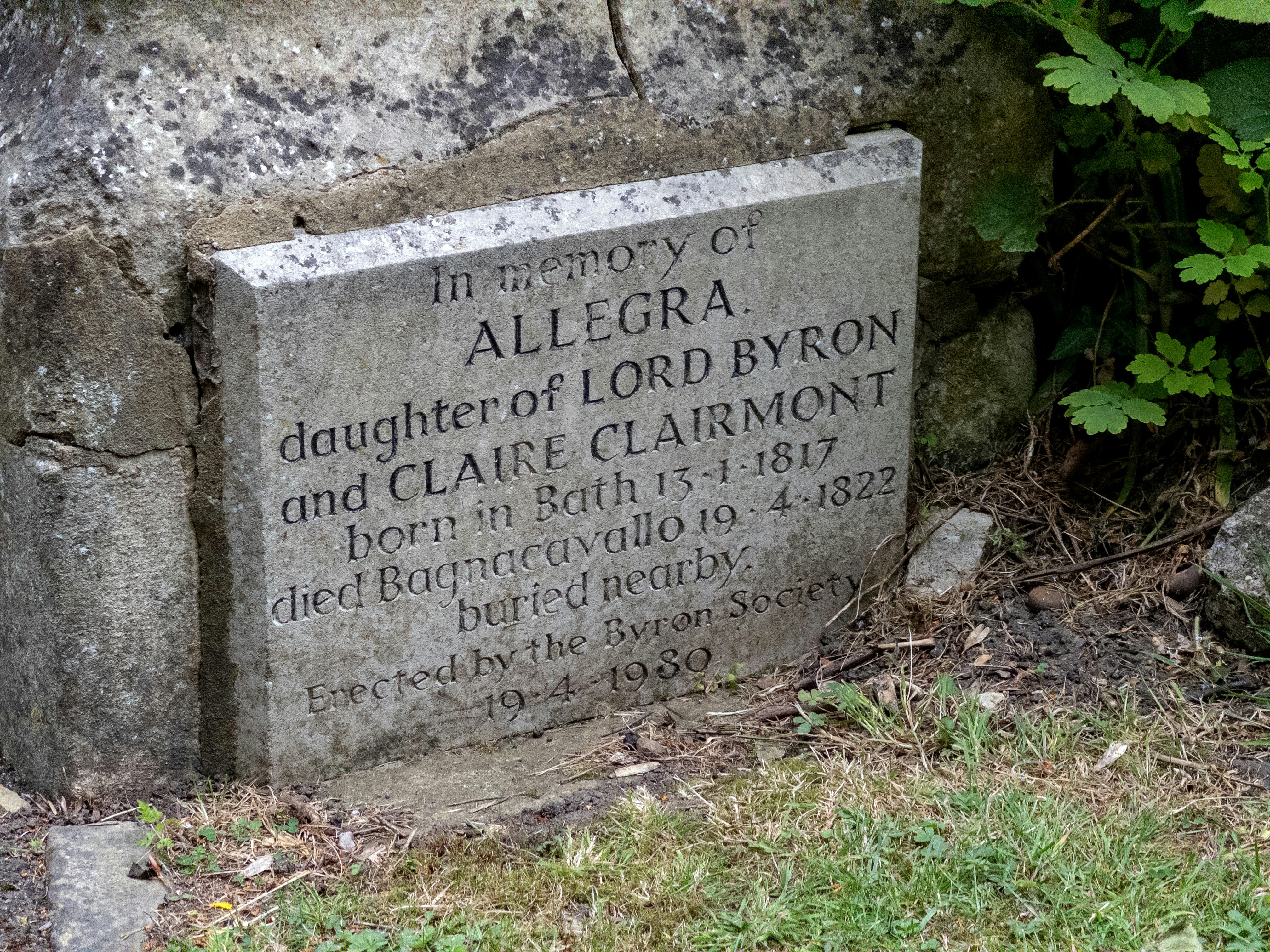 Stone Memorial Grounded in Moss and Memory