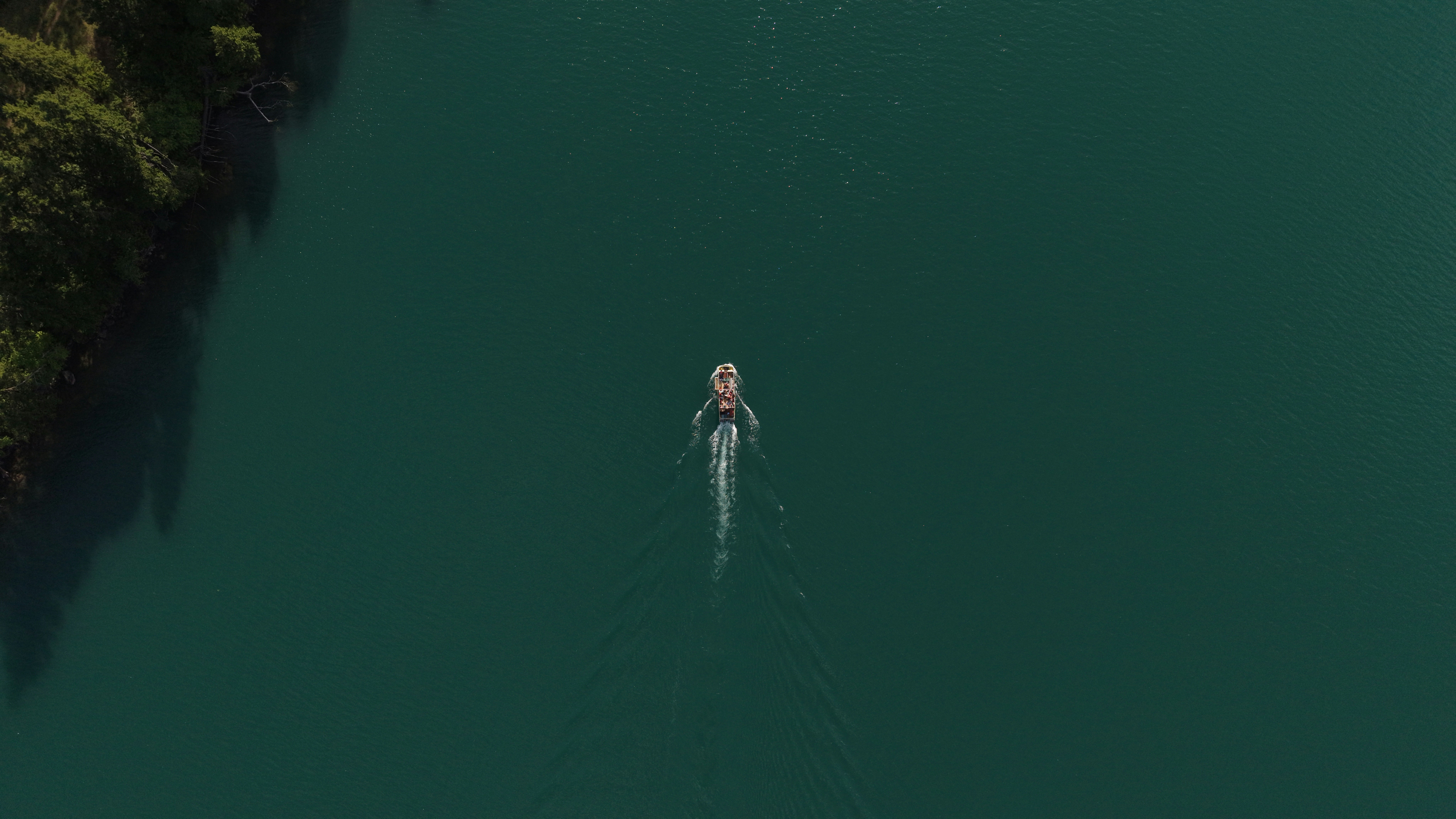 Solo swimmer glides through a quiet teal expanse