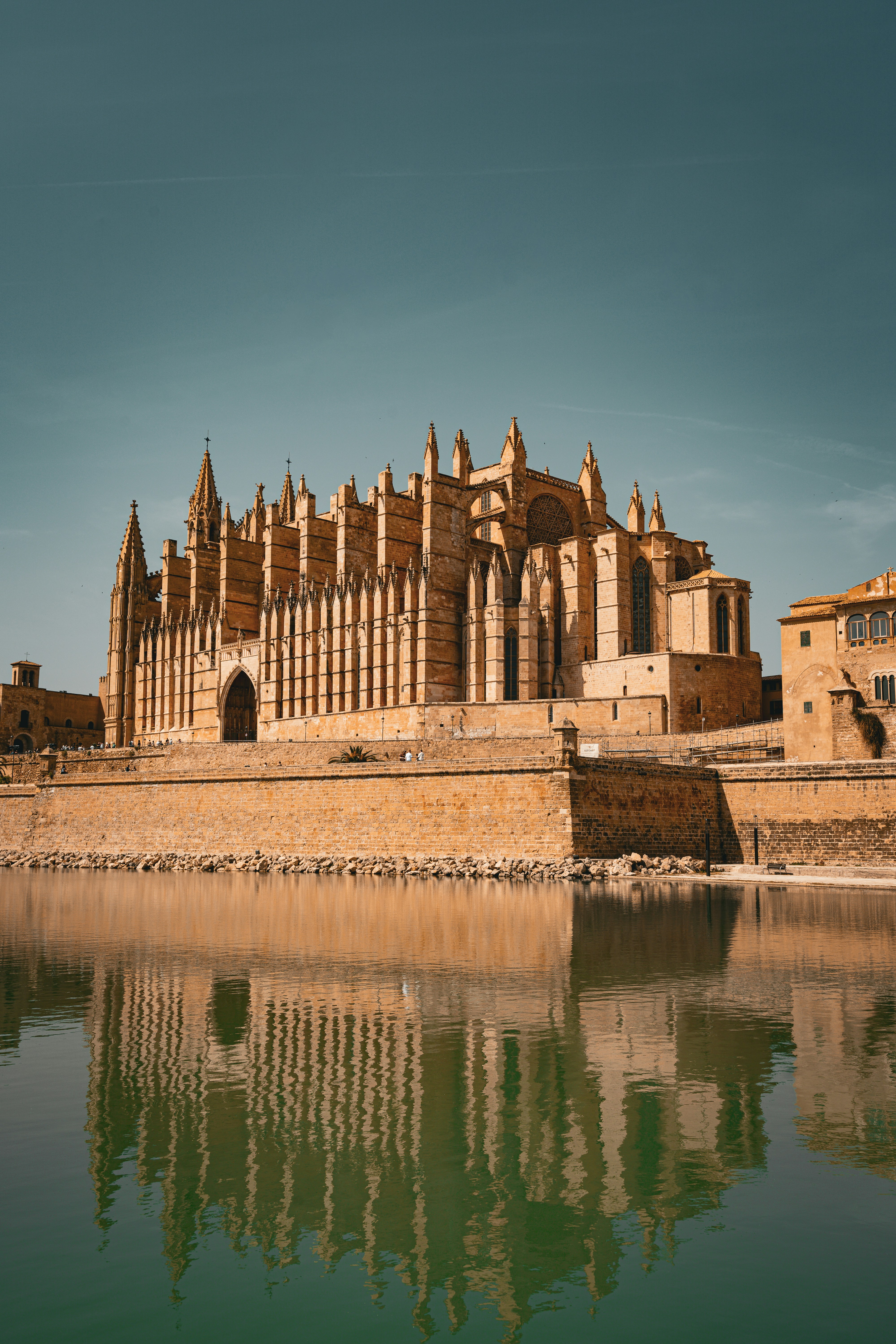  fortress by the water: a sunlit abbey rises above calm reflections